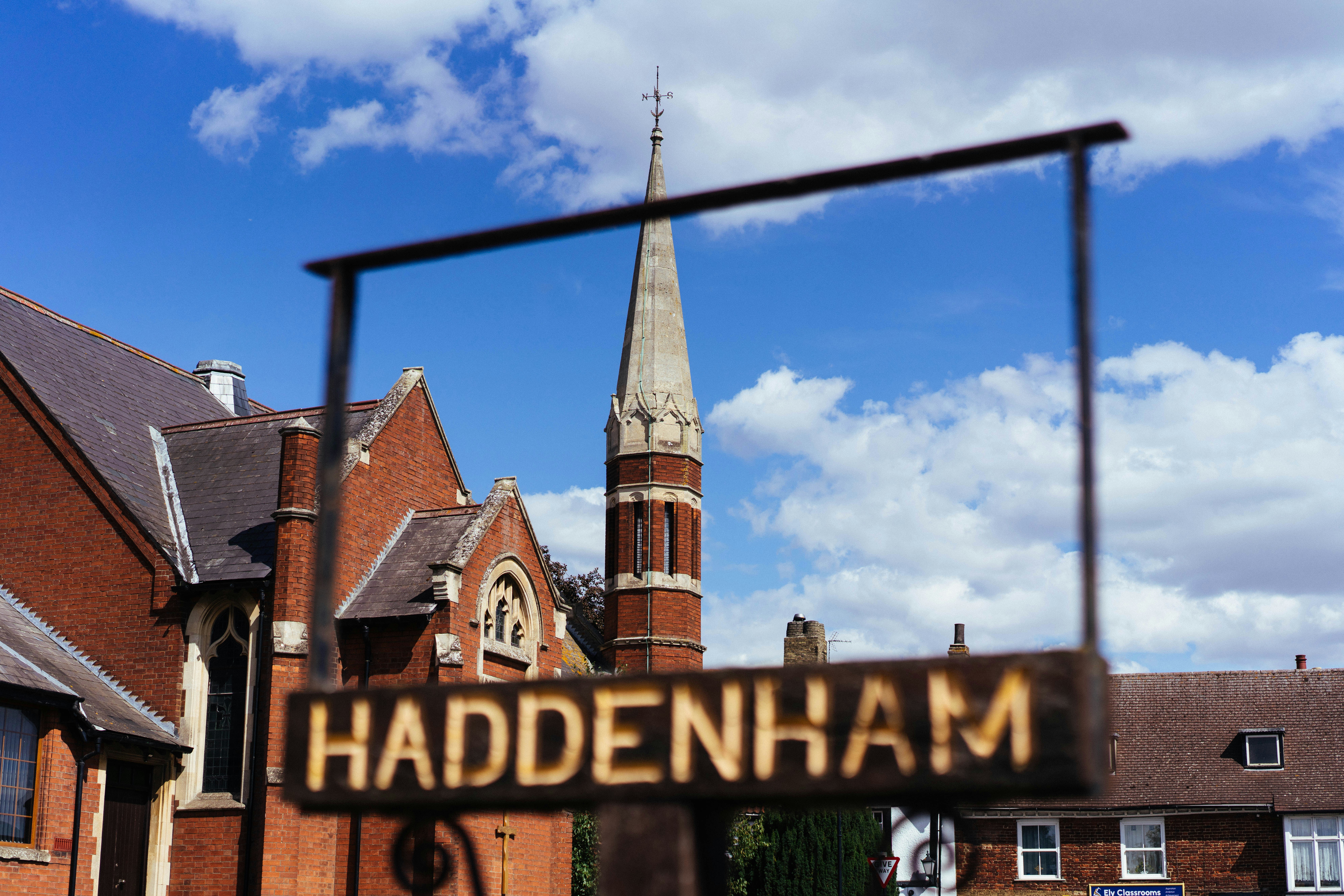 Blurred Sign, Timeless Spire: A Stately Town Scene