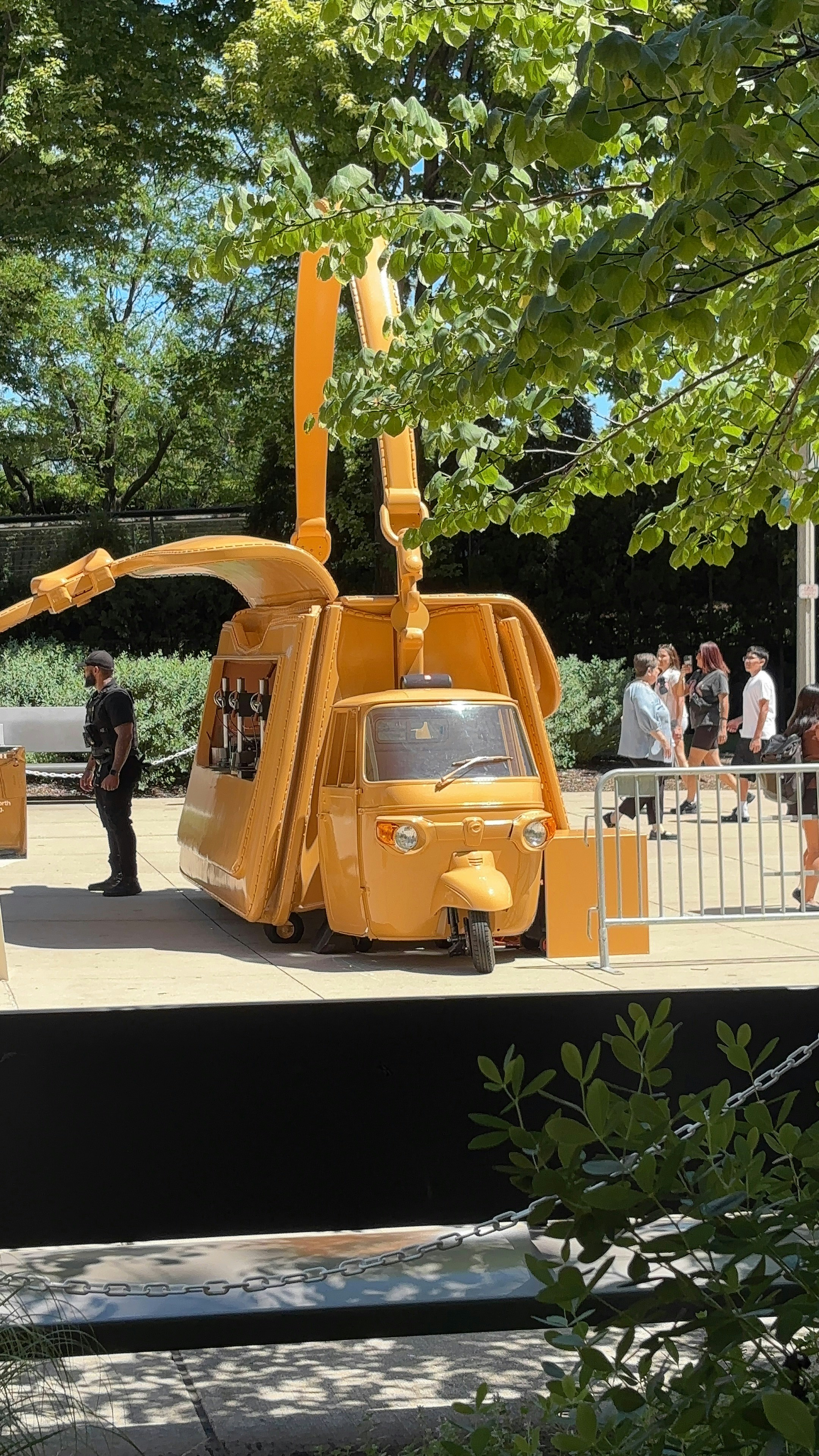 Sunlit Yellow Movie Carriage: Aerial Arcade in the Park