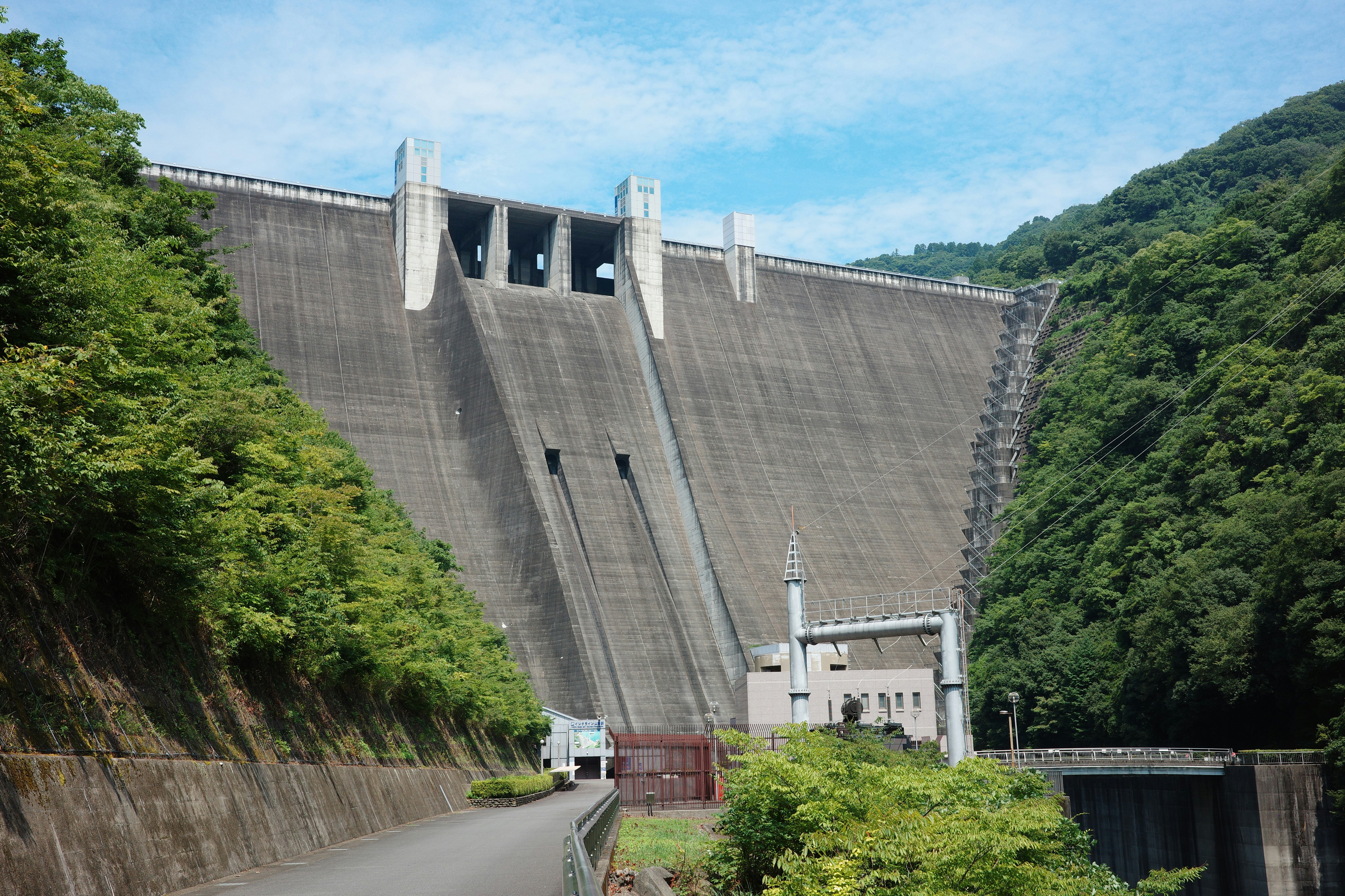Concrete Leviathan: A Dam Reaching into the Blue Sky