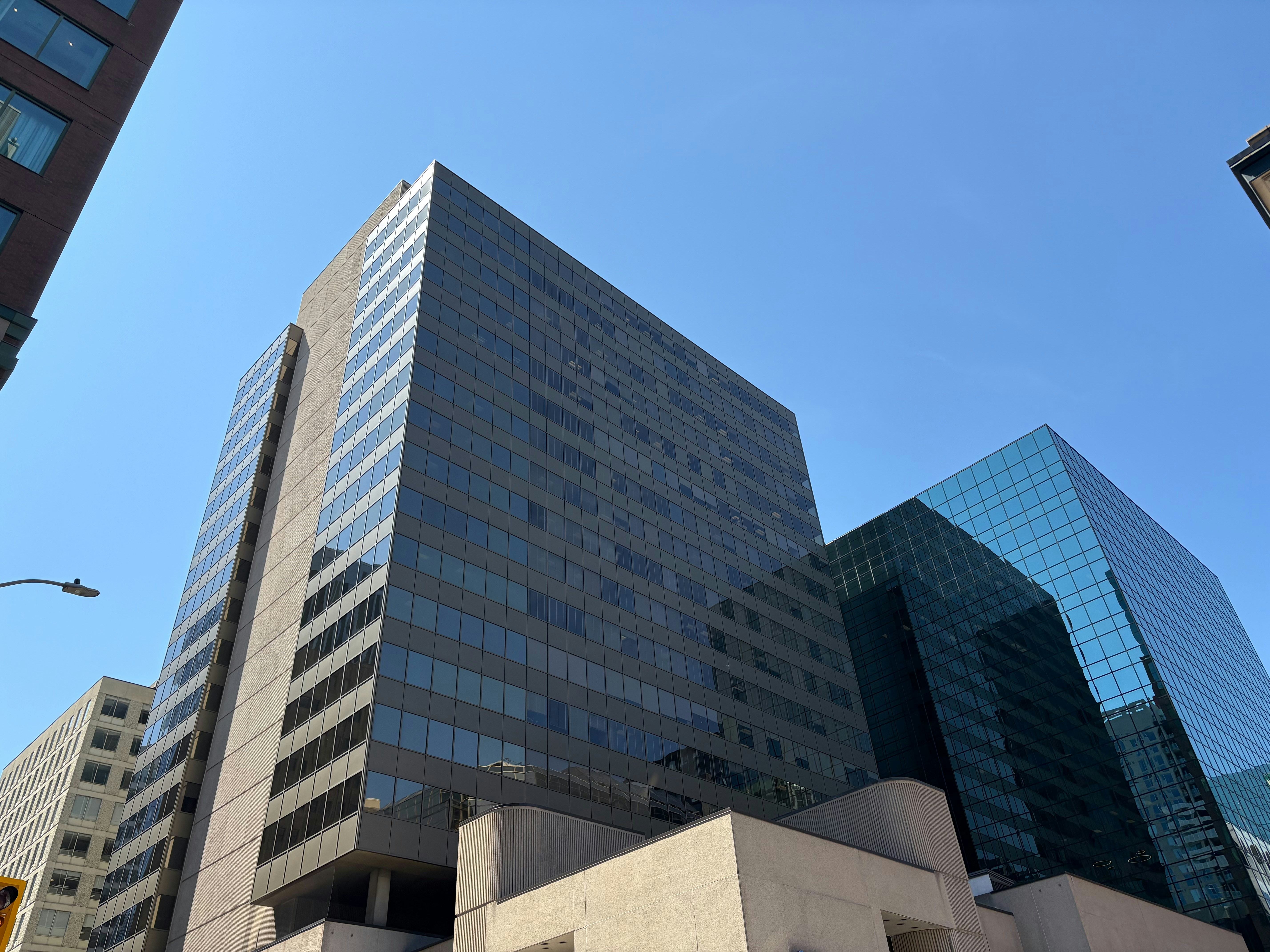 Glass-and-concrete Skyward: A Trio of Modern Towers Against a Clear Blue