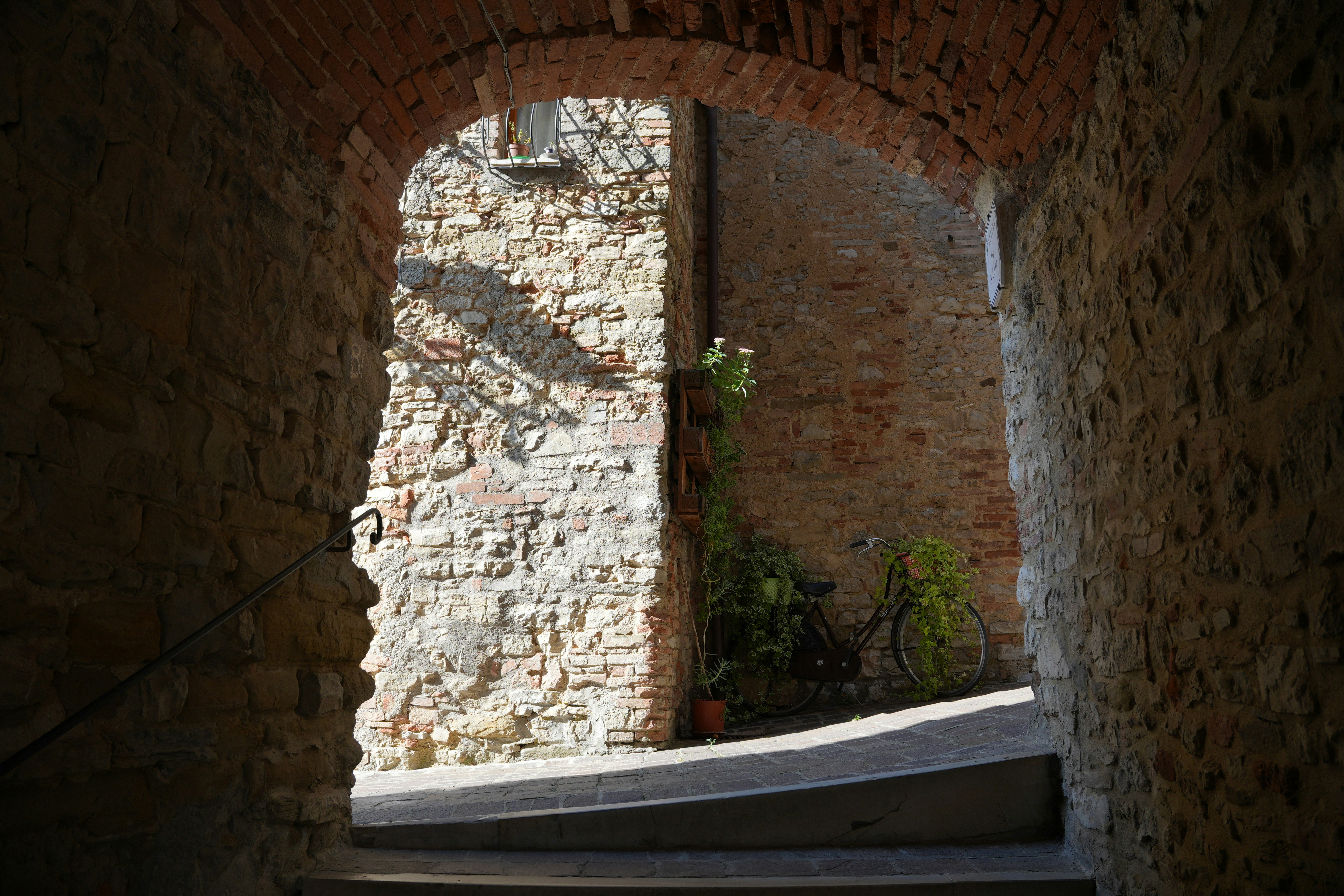Stone Archway to a Sunlit Courtyard