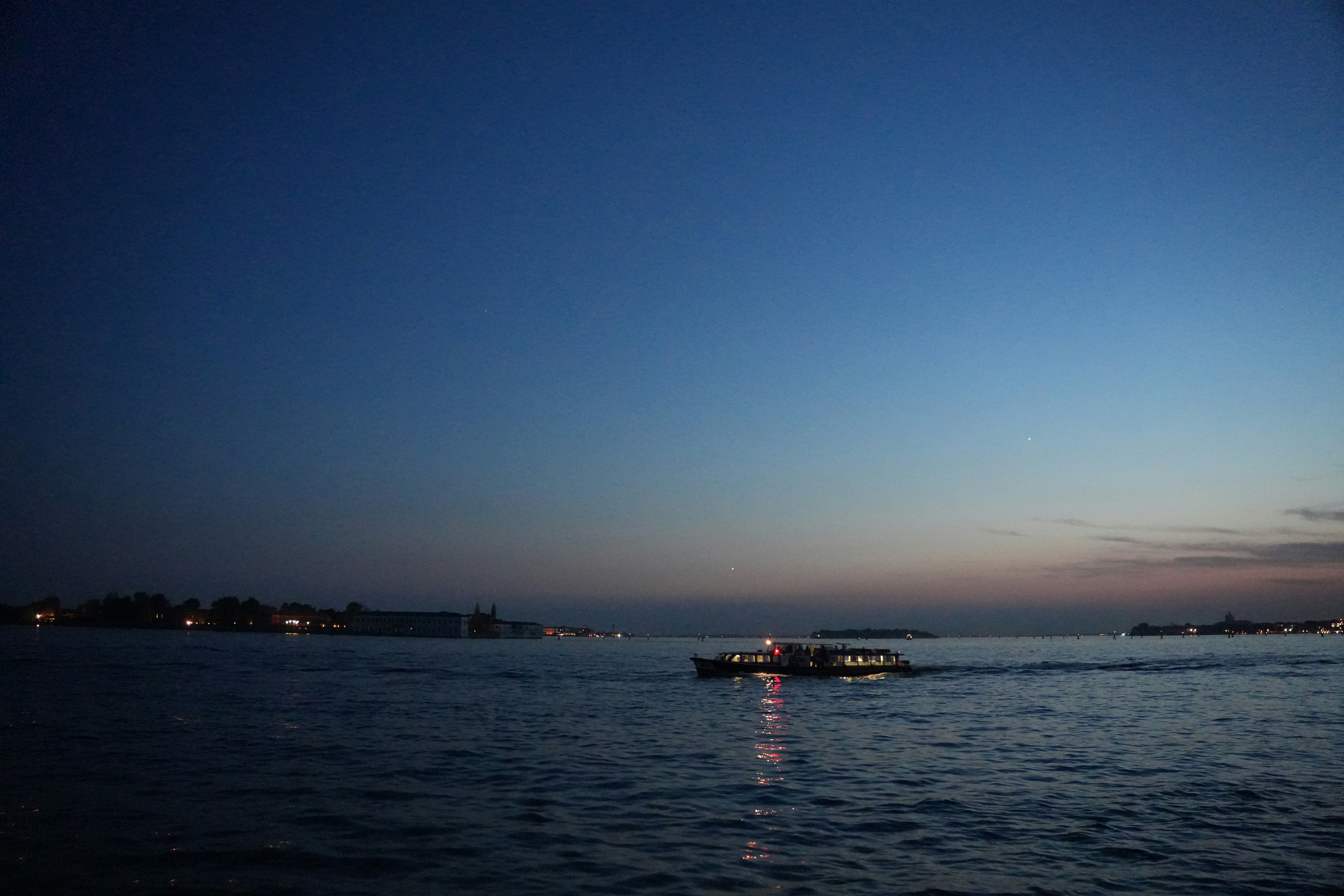 Low-contrast Ferry at Dusk: Echoes of Twilight Across the Water