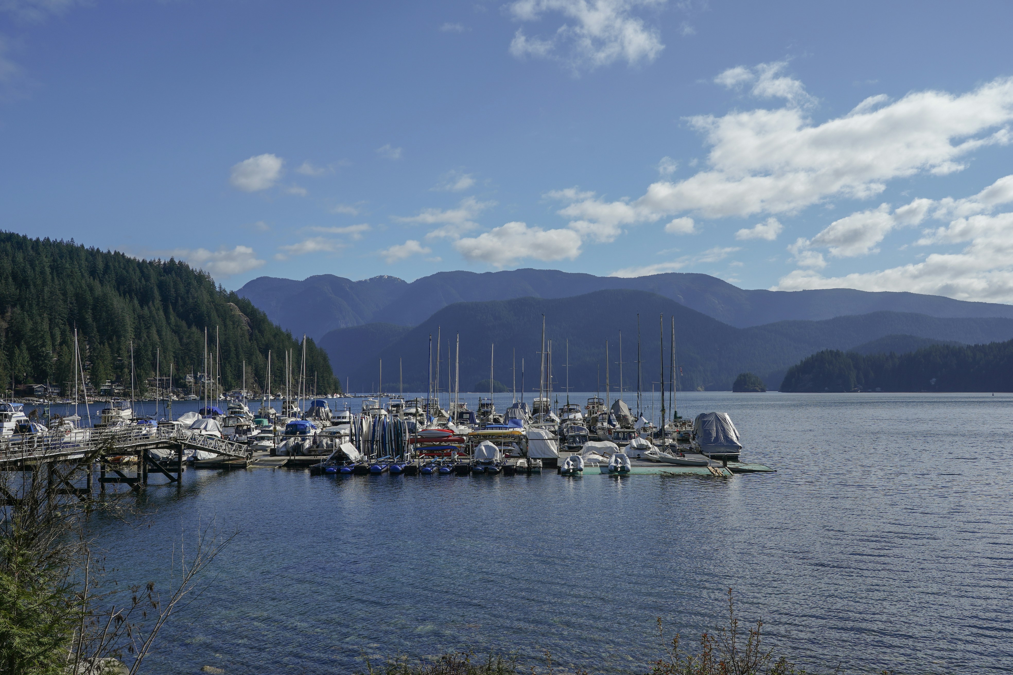 Harbor of Silence: Boats Rest at Dusk Amid Mountain Backdrop