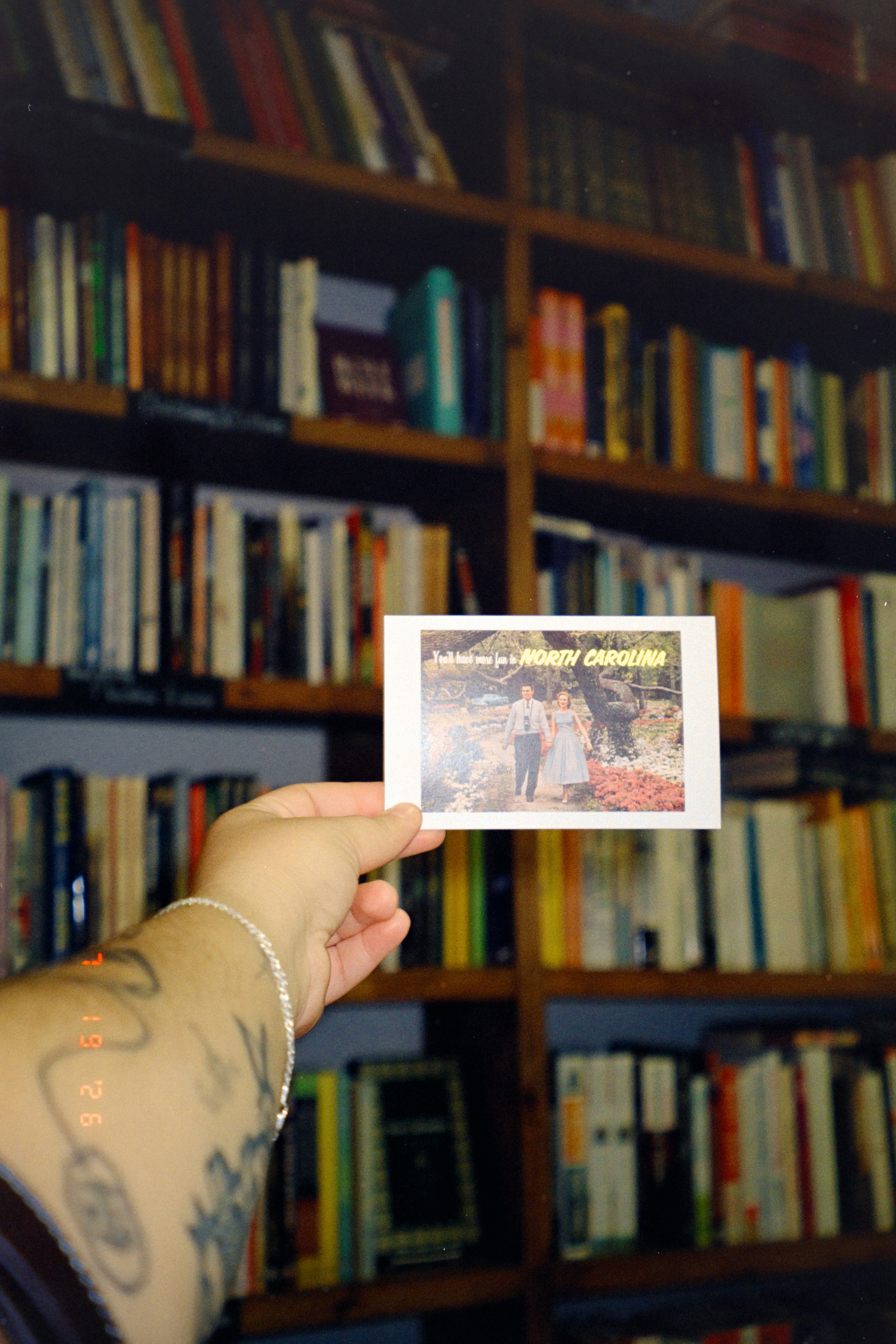 Polaroid Moment in a Library: Handheld Memory Between Shelves