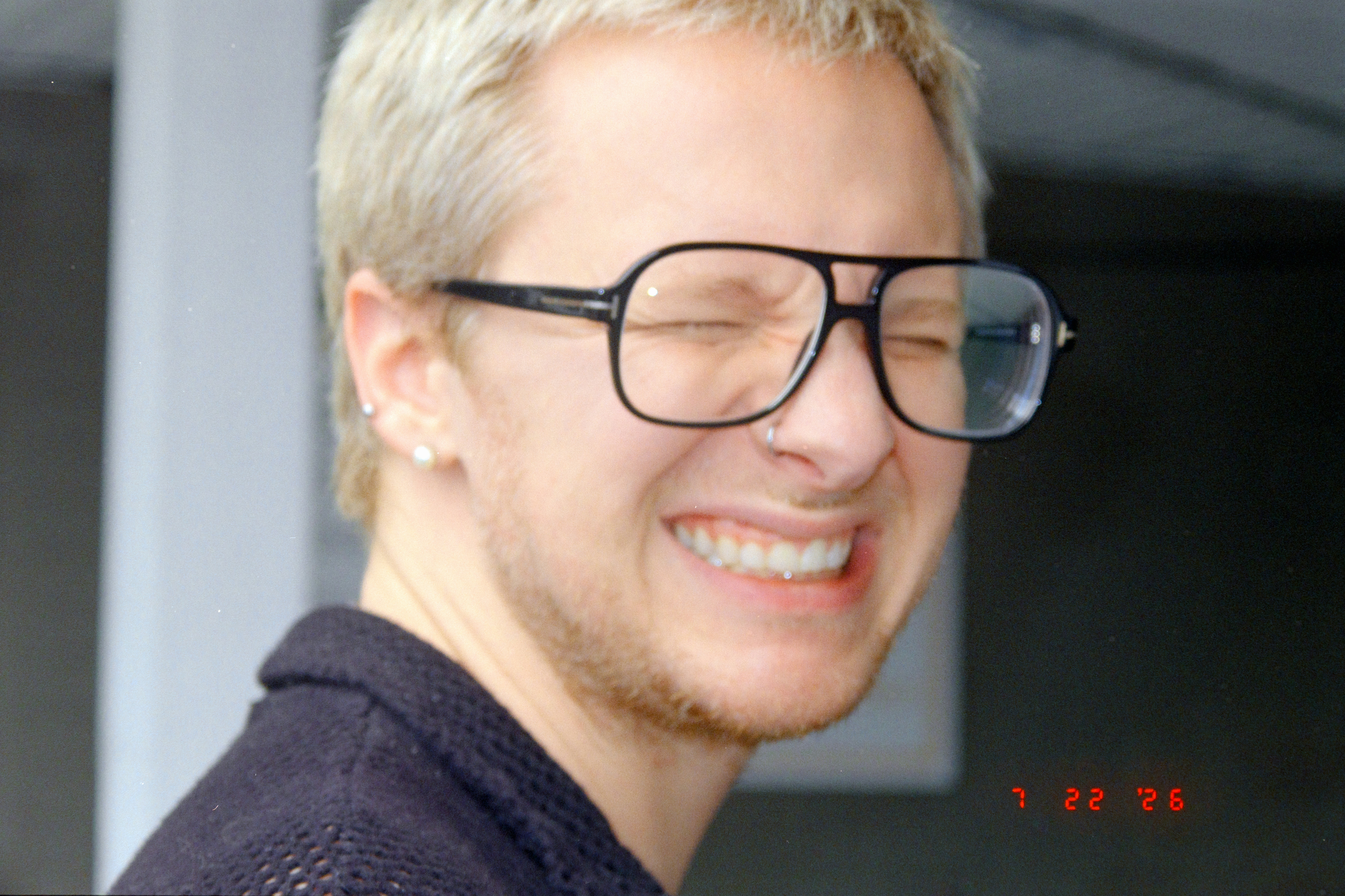 Close-up of a smiling face with oversized glasses