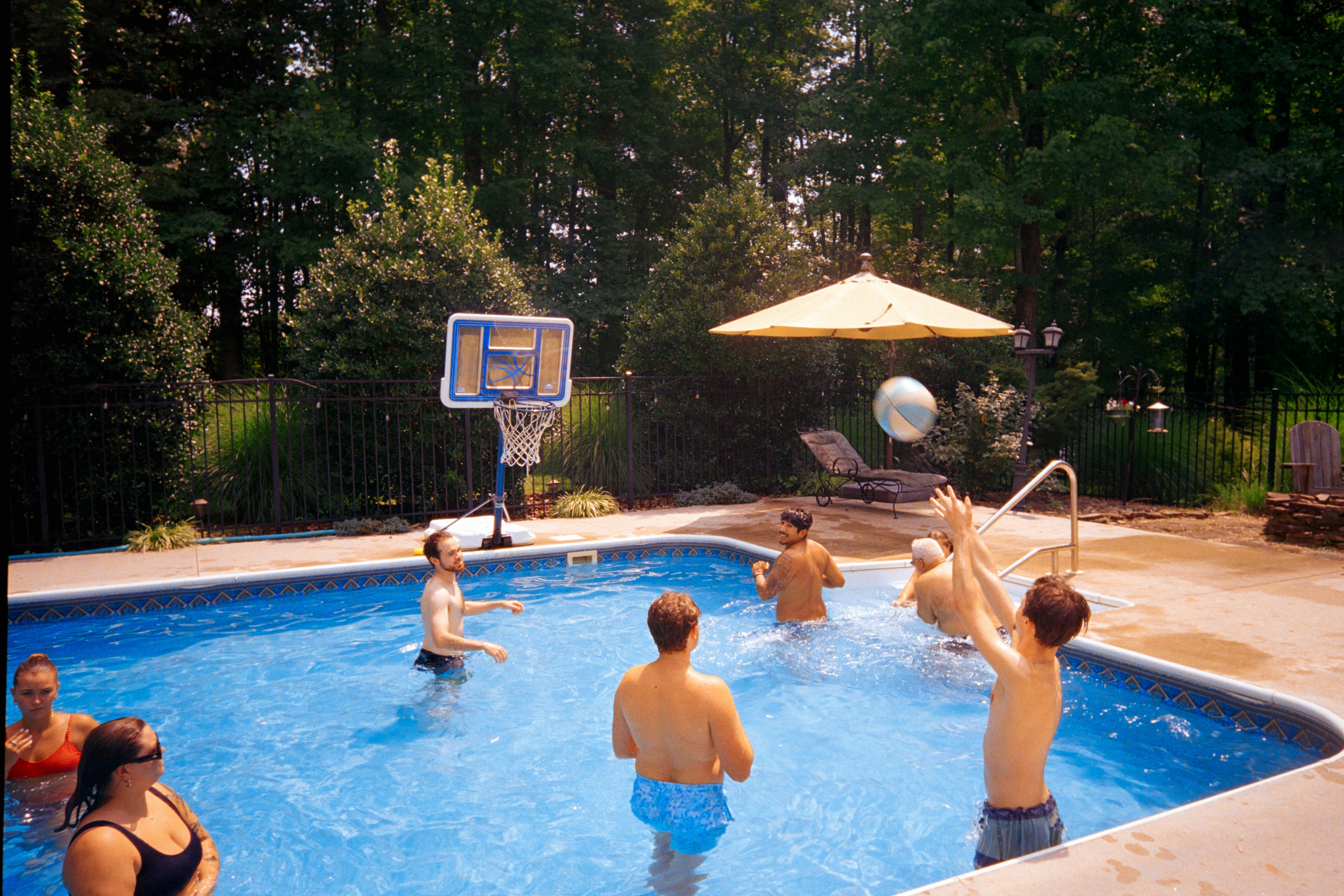 Sunlit Poolside Pickup: A Basketball Moment Under the Summer Sky