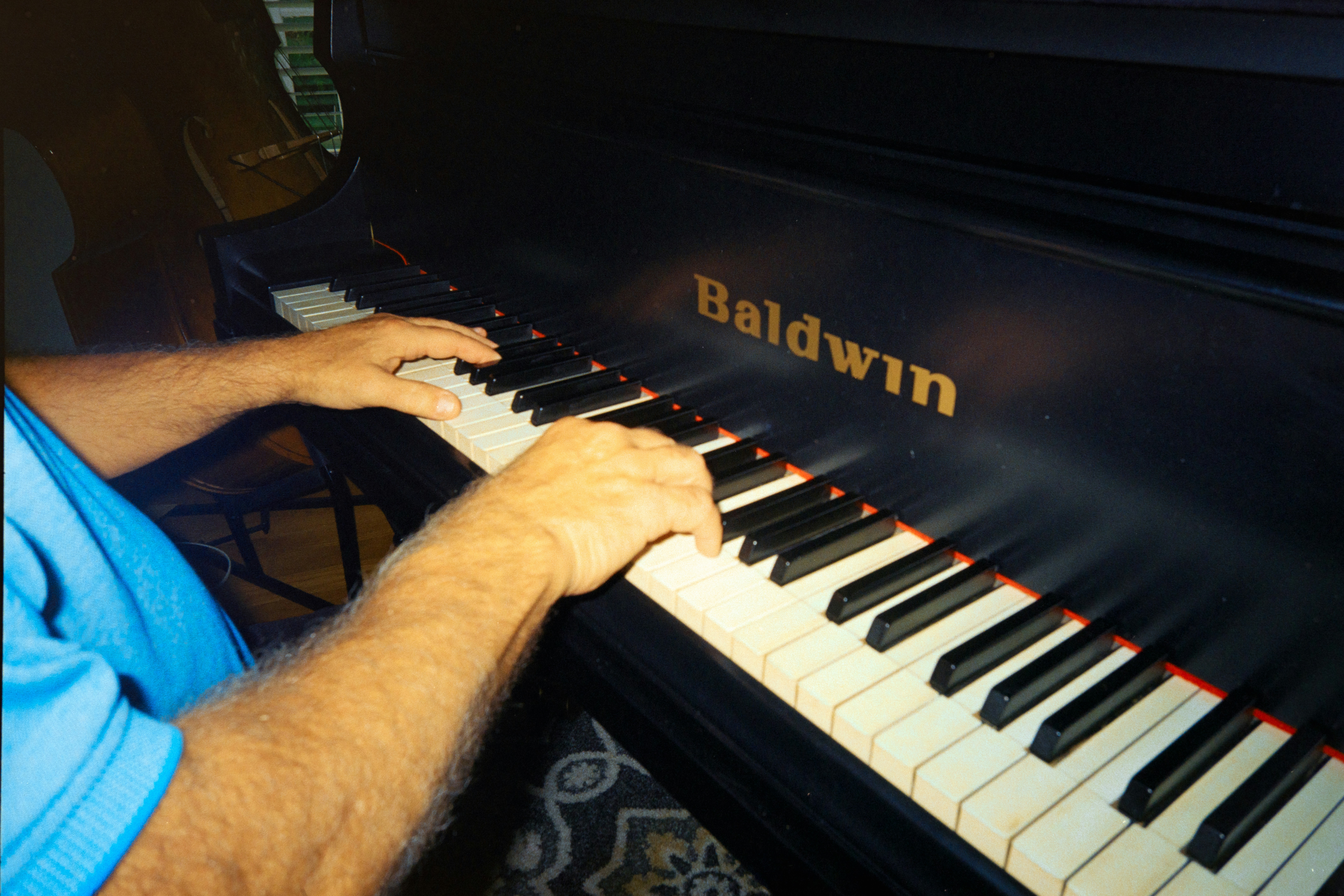 Midnight Keyboard: Hands Dancing Across a Baldwin Grand