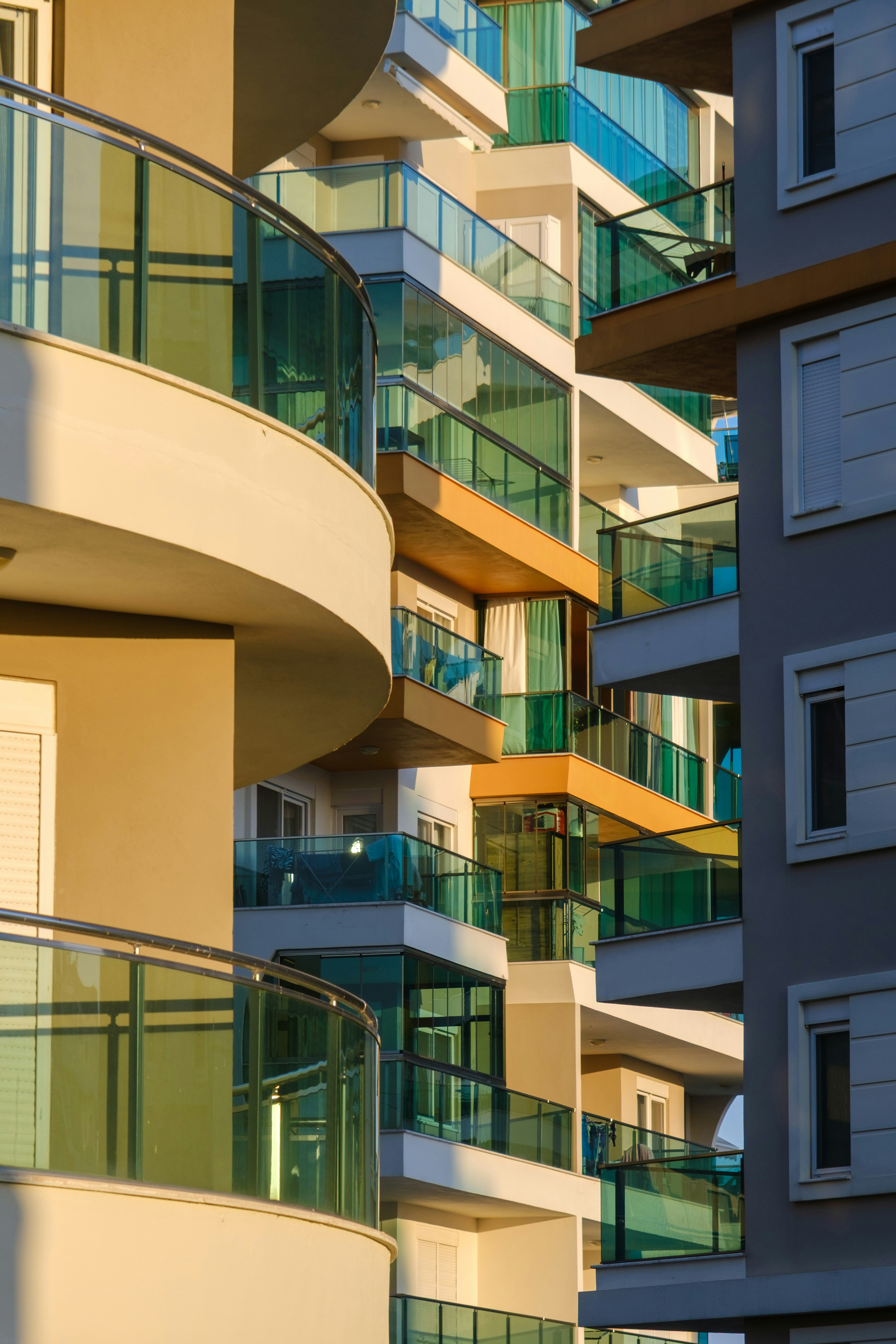 Cascade of Glass Balconies Wrapped in Sunlit Geometry