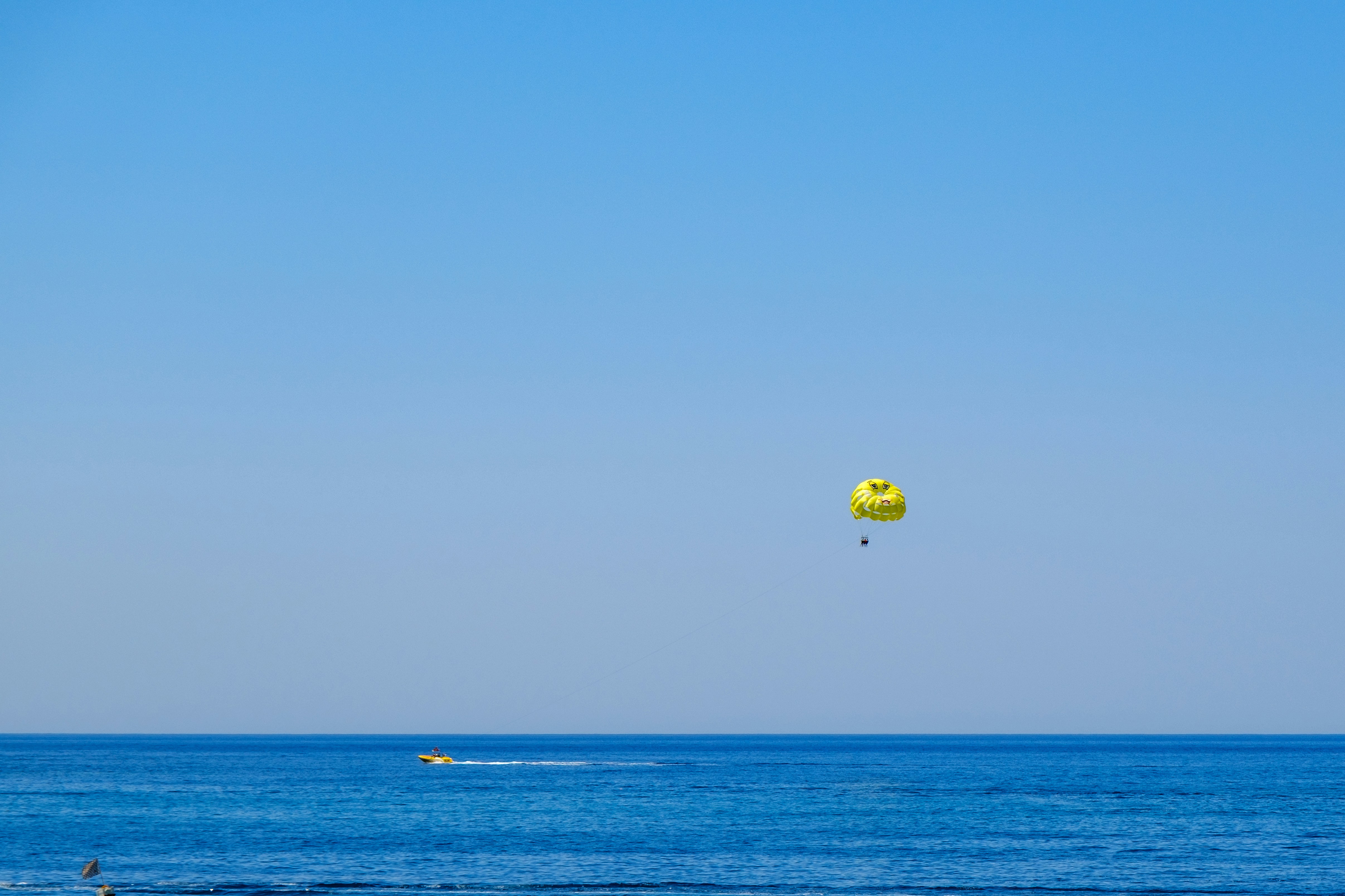 Yellow Parasail Against a Cerulean Horizon