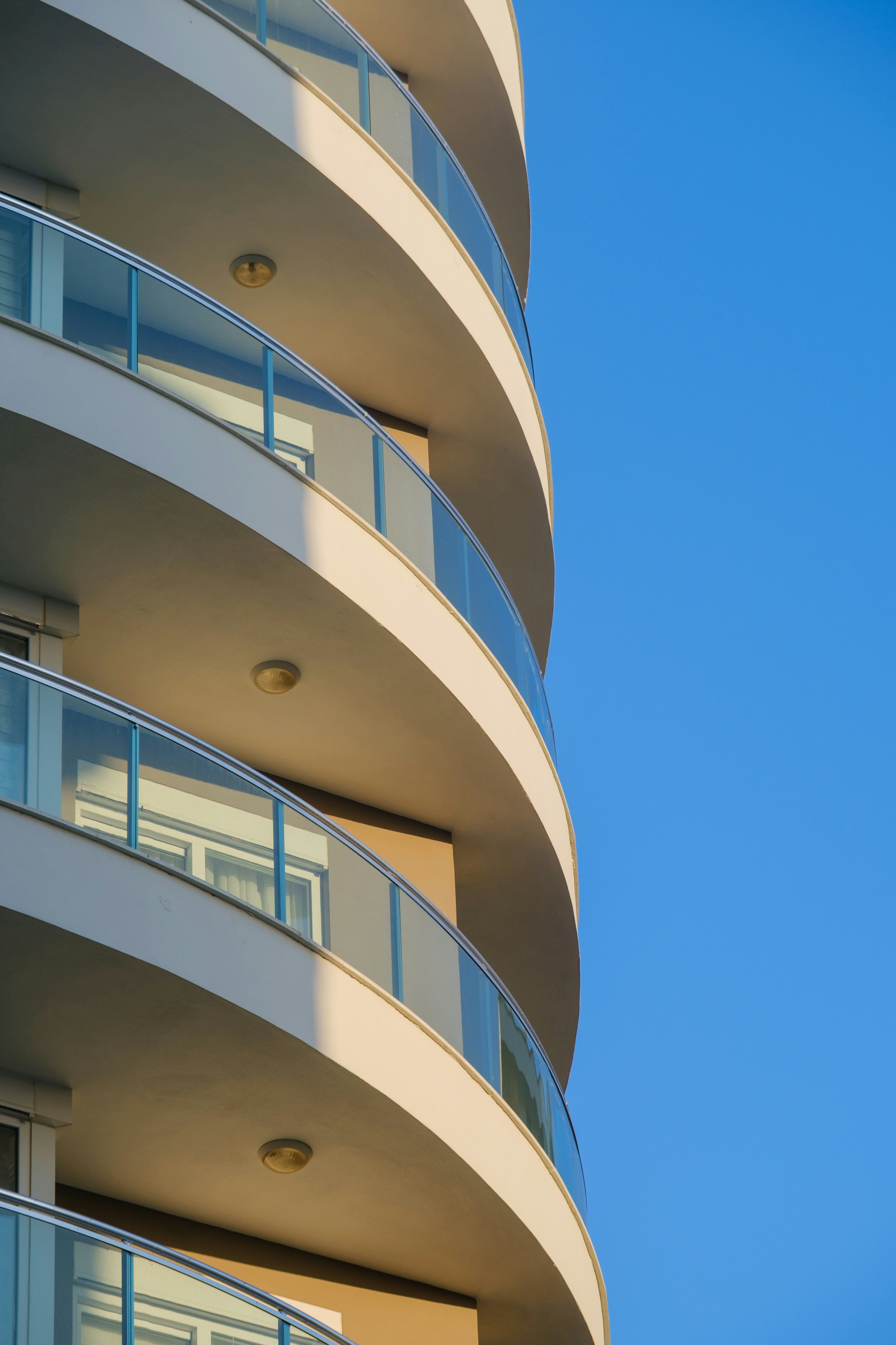 Curved Horizons: A Modern Balcony Sequence Against a Crisp Blue Sky