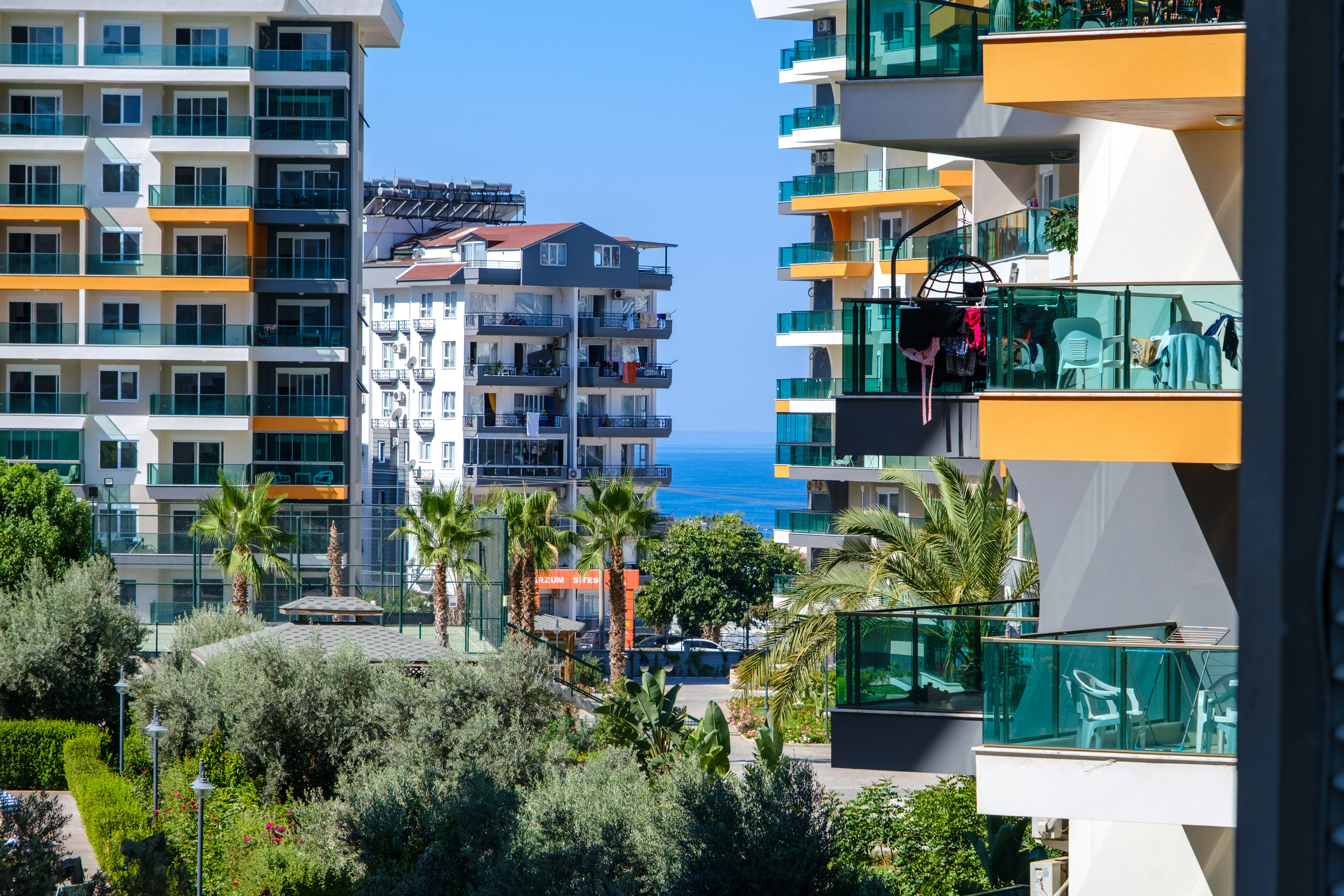 Balconies and Ocean Vista: A Sunlit Corridor Between Modern Towers