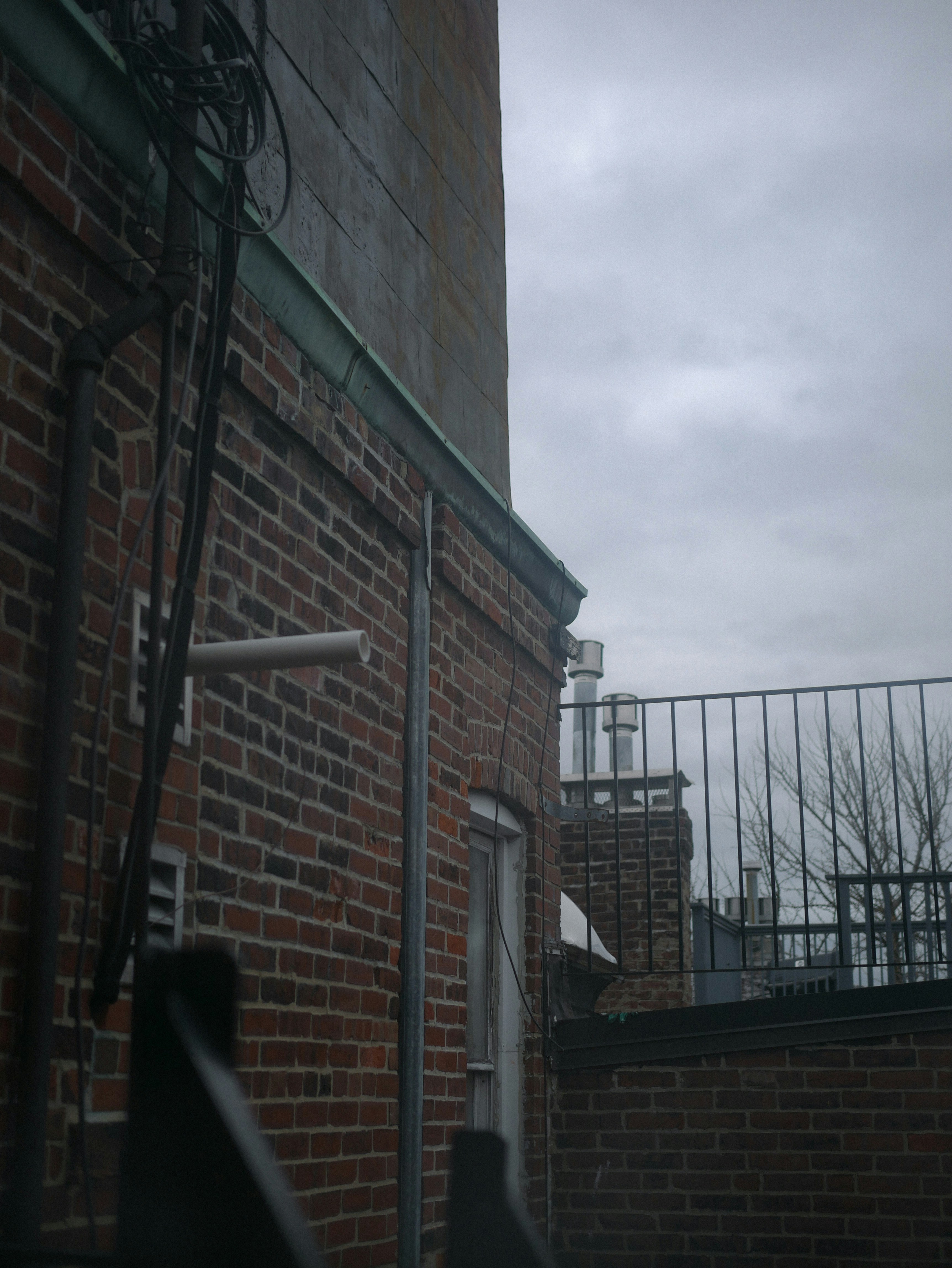 Brickwork and Rooftop Lines: An Industrial Alley Portrait