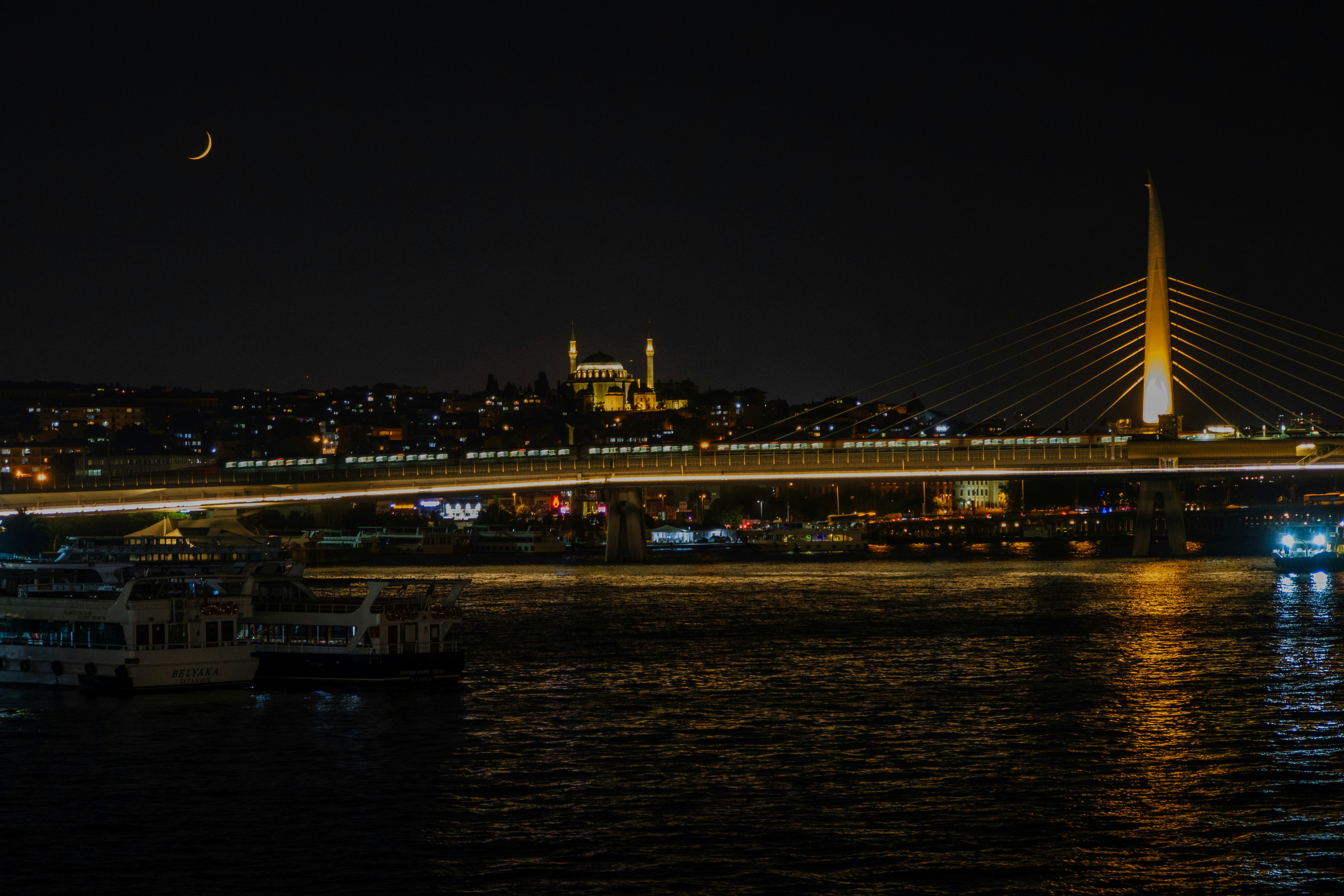 Moonlit River Overpass: City Lights Reflect on Quiet Waters