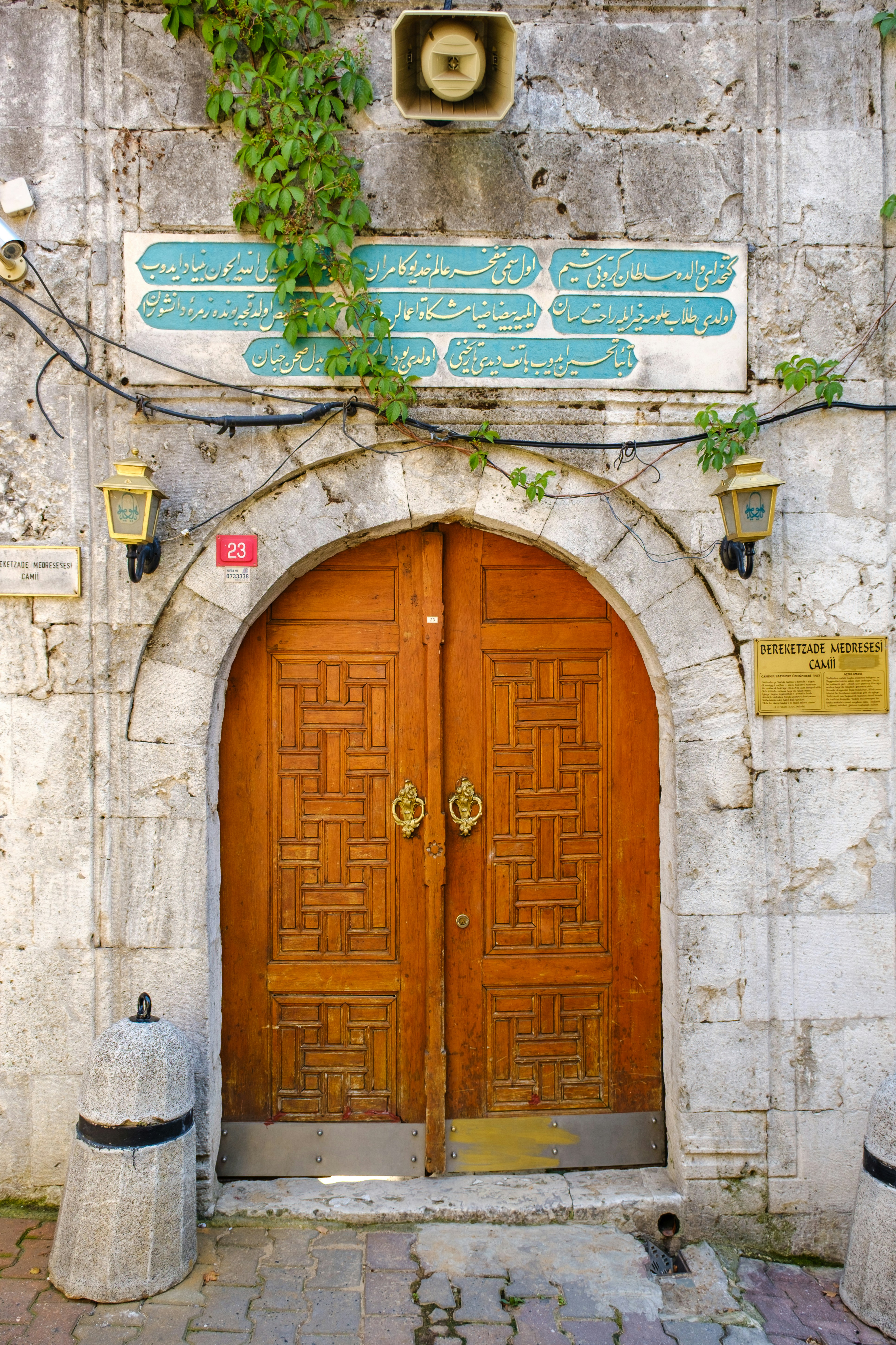 Carved Cedar Doors of a Stone Archway