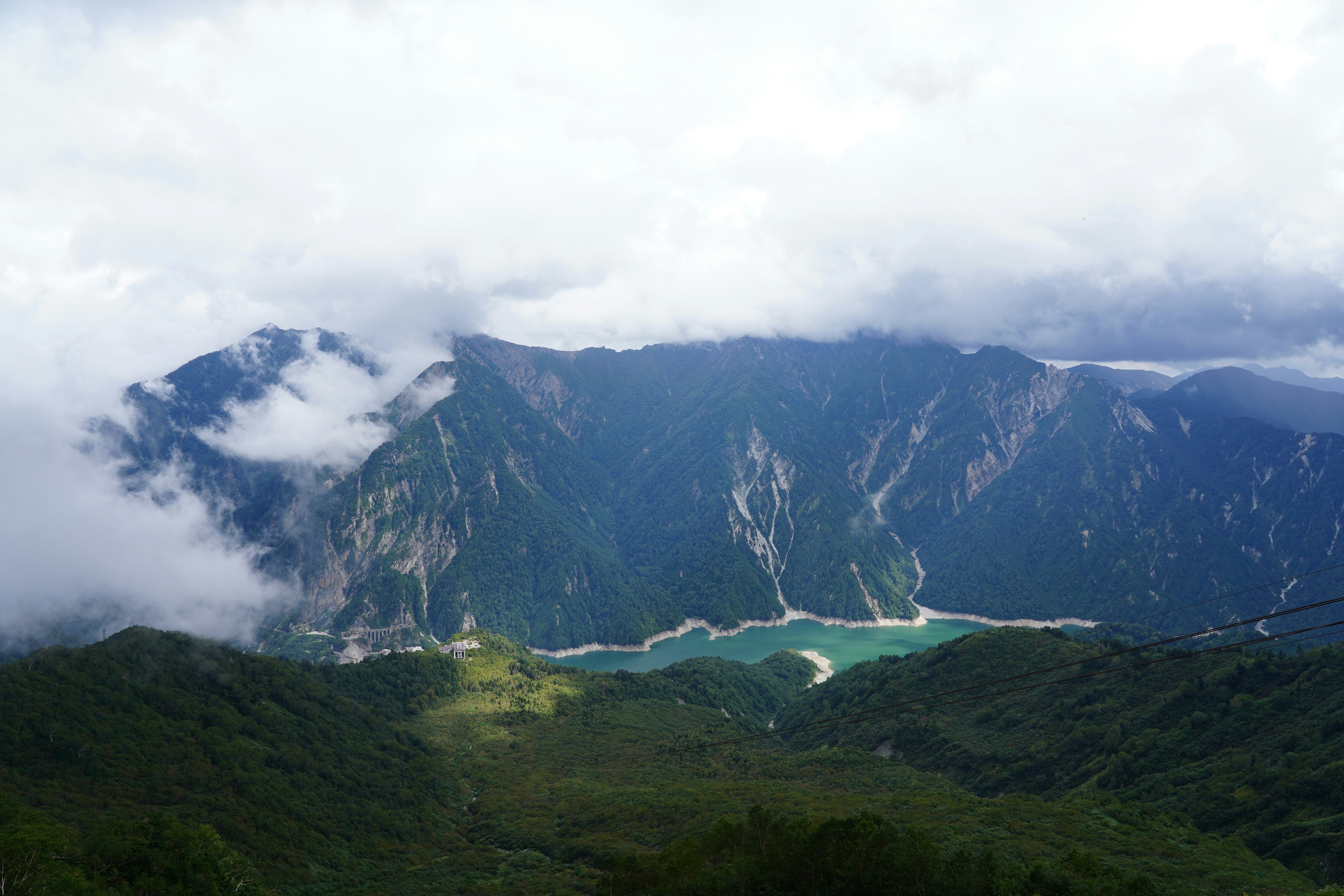 Emerald Inlet Between Cloud-Kissed Ridges