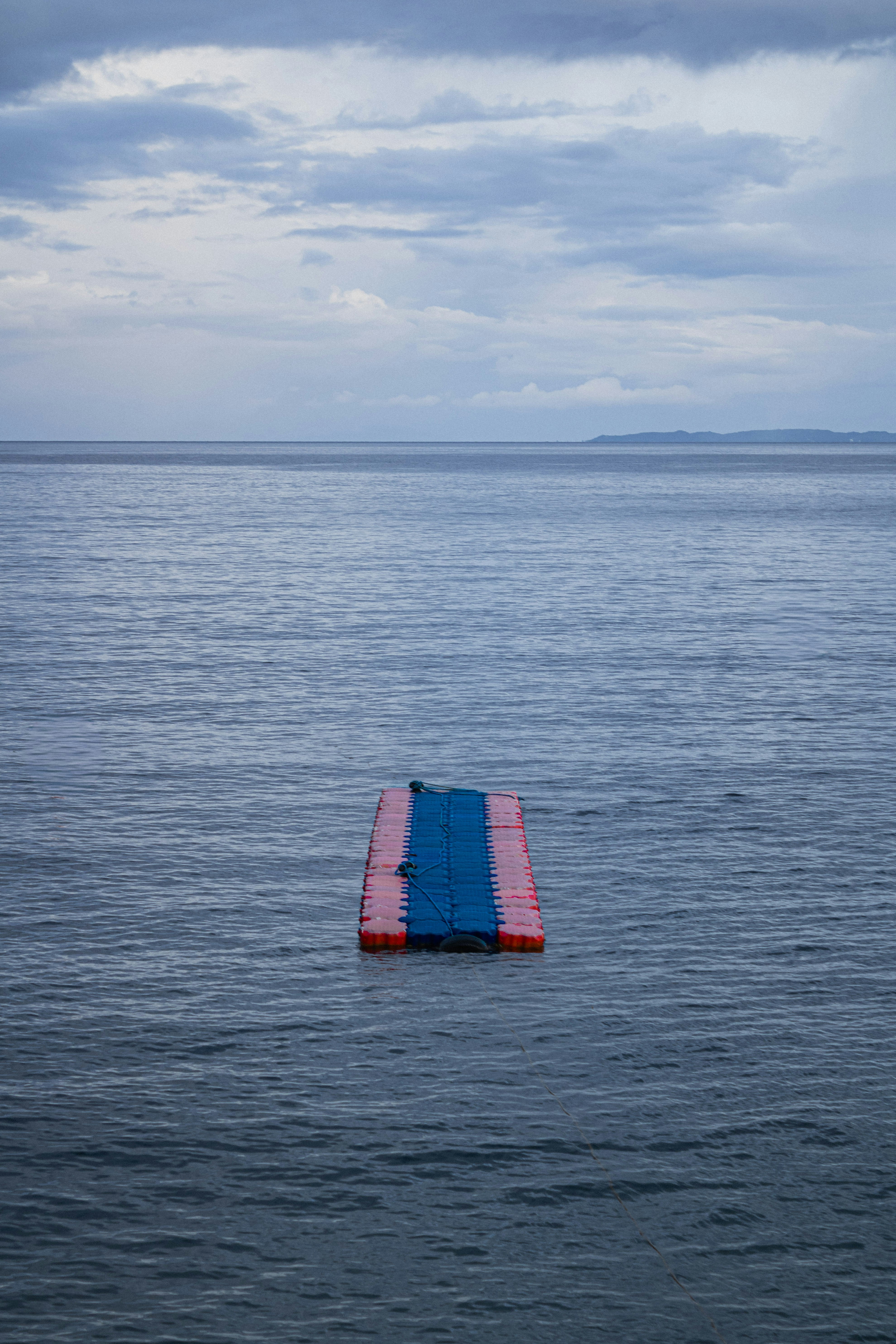 Floating Path: A Red-Blue Bar by the Quiet Horizon