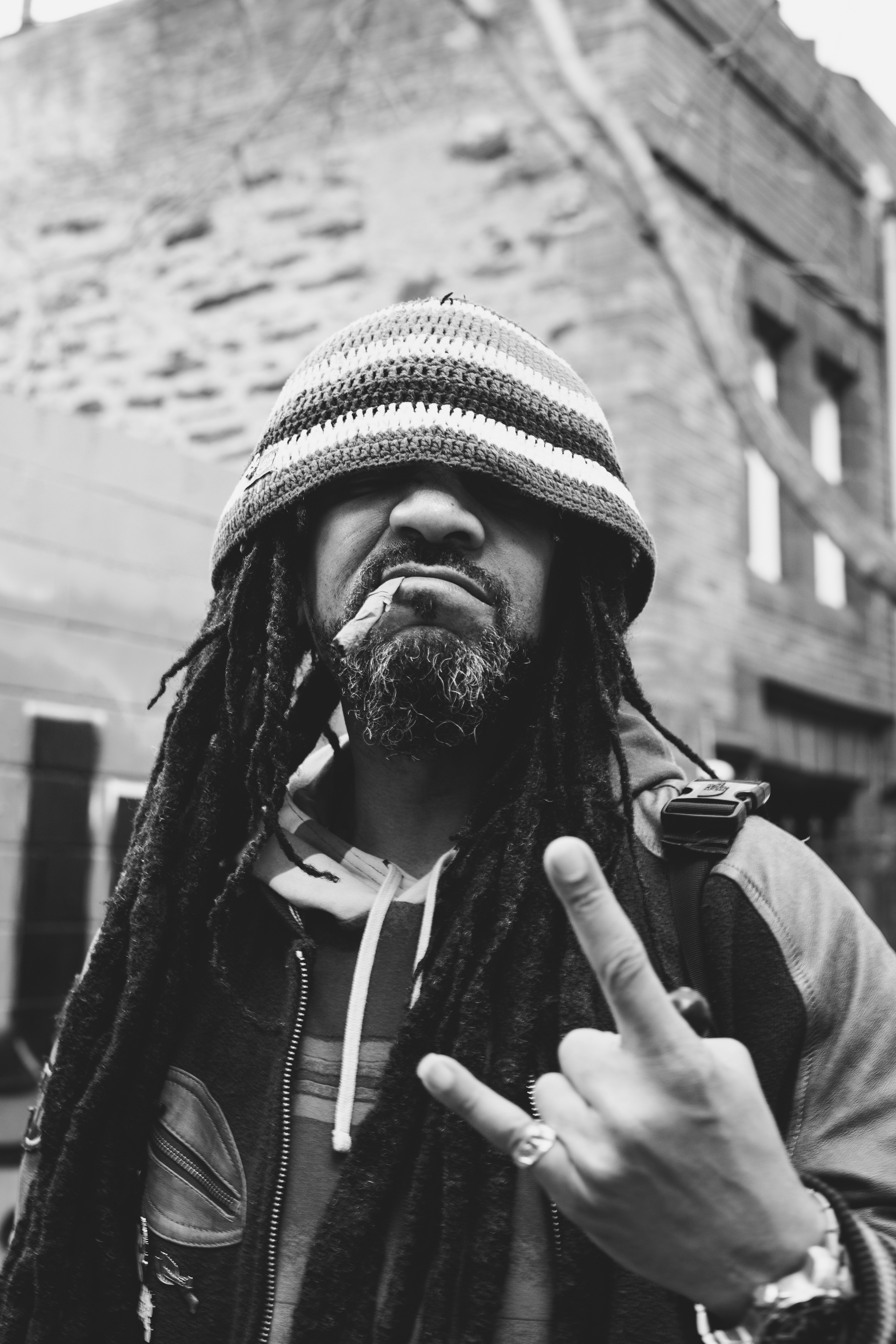 Masked defiance: a gritty urban portrait behind the beanie