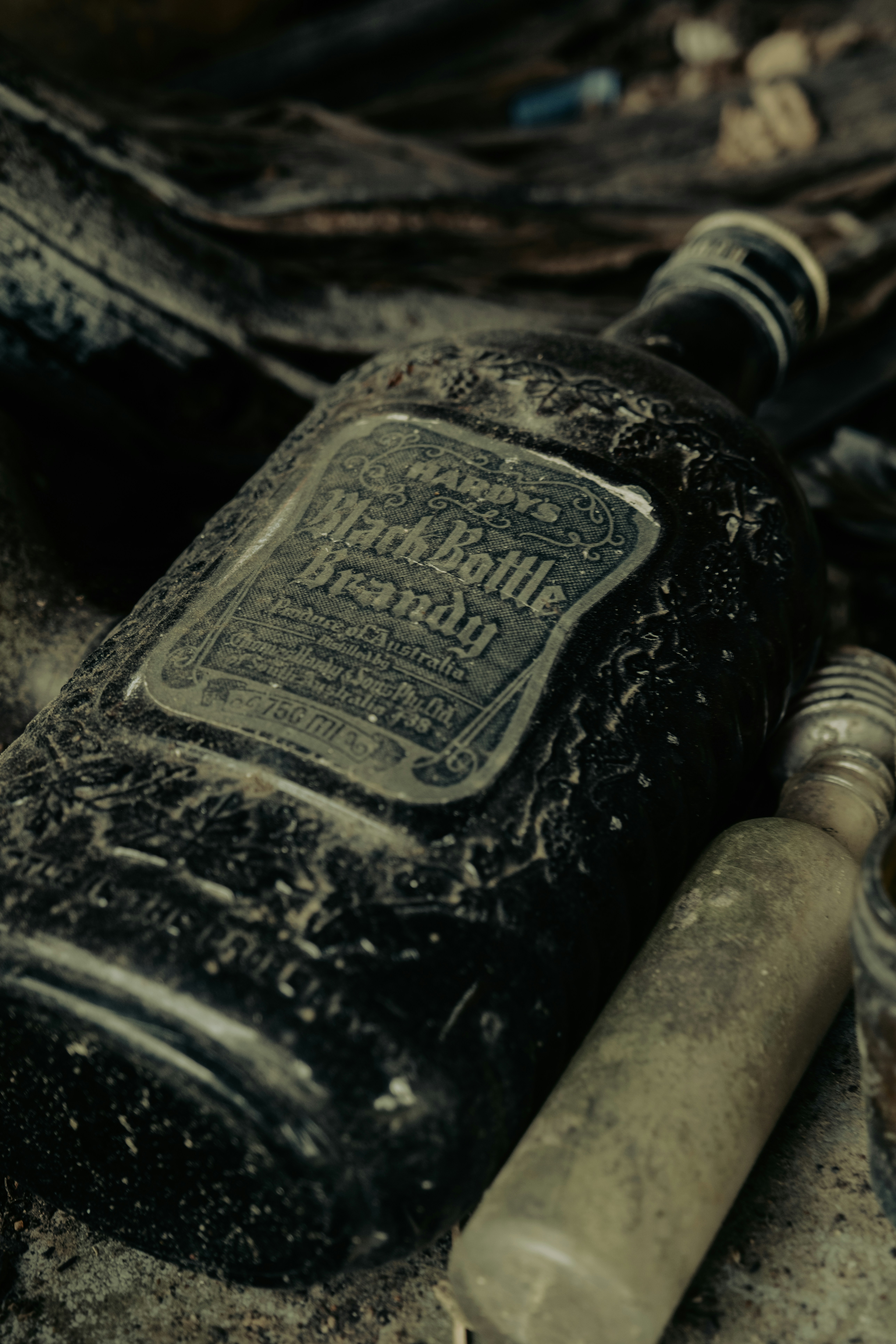 Dusty Bottle of Bourbon in a Dark Sandbox