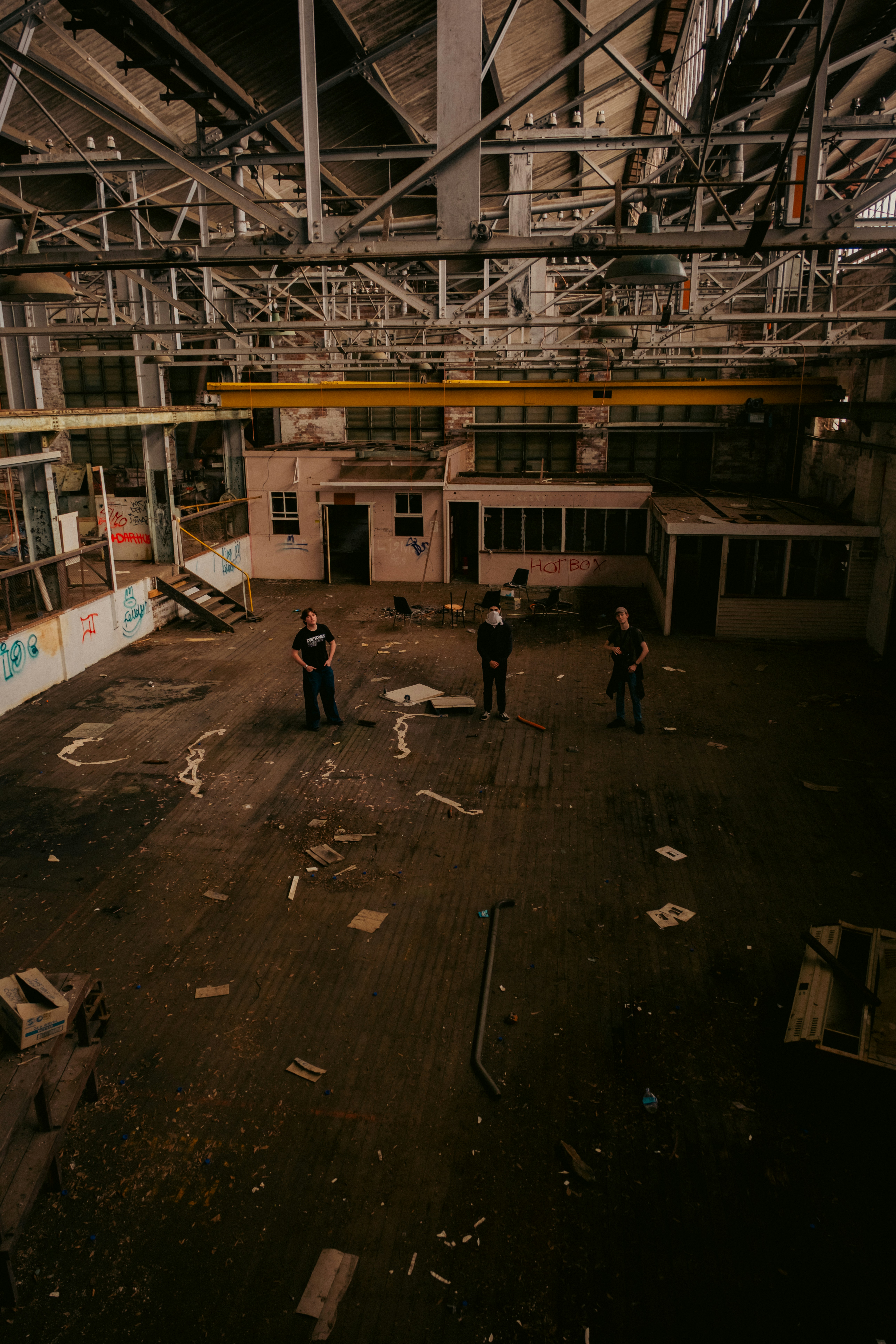 Three Figures in a Deteriorated Factory: Quiet Stand of Resolve