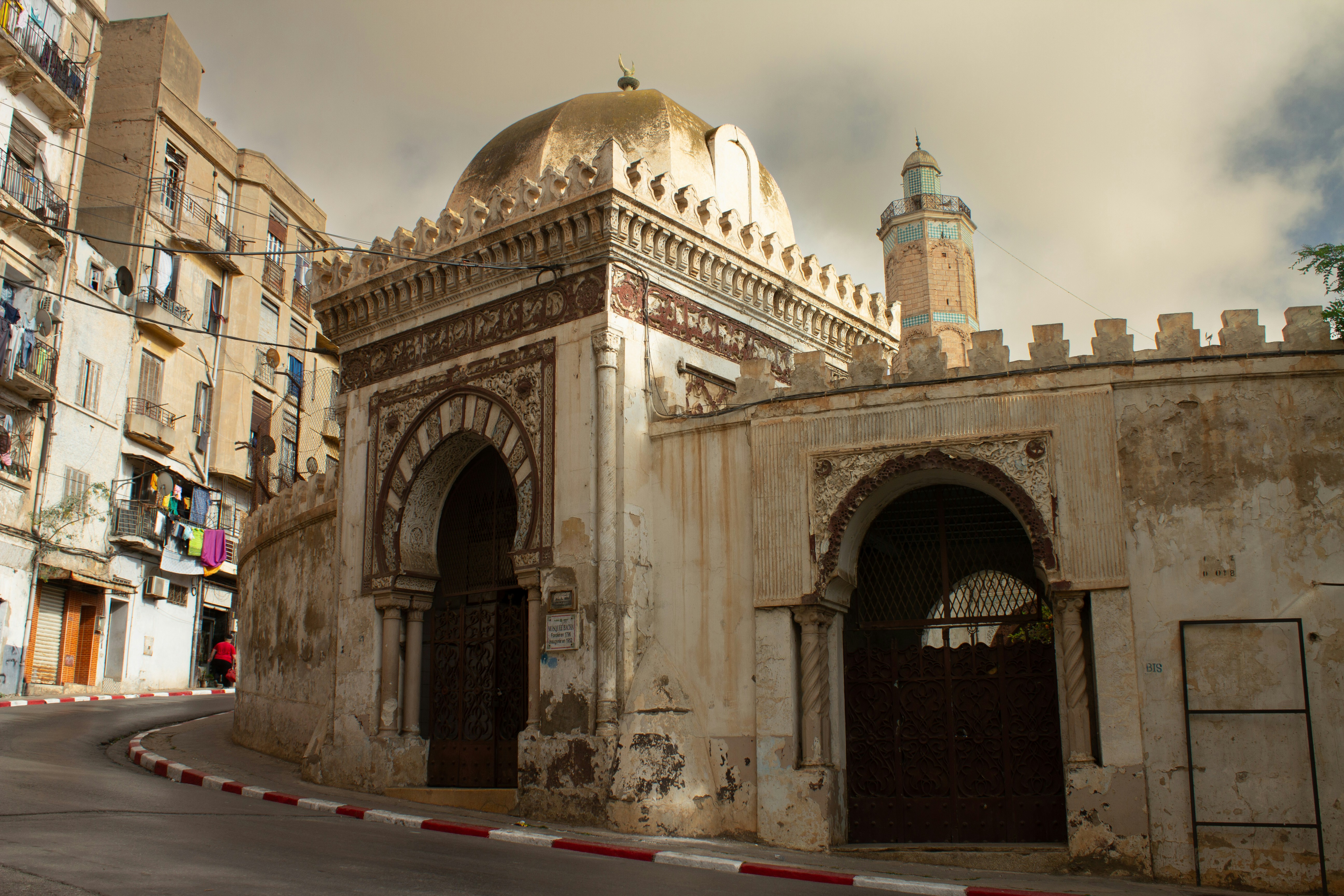 Archway of Time: A Weathered Gatewatcher Between Street Life and Old Fortitude