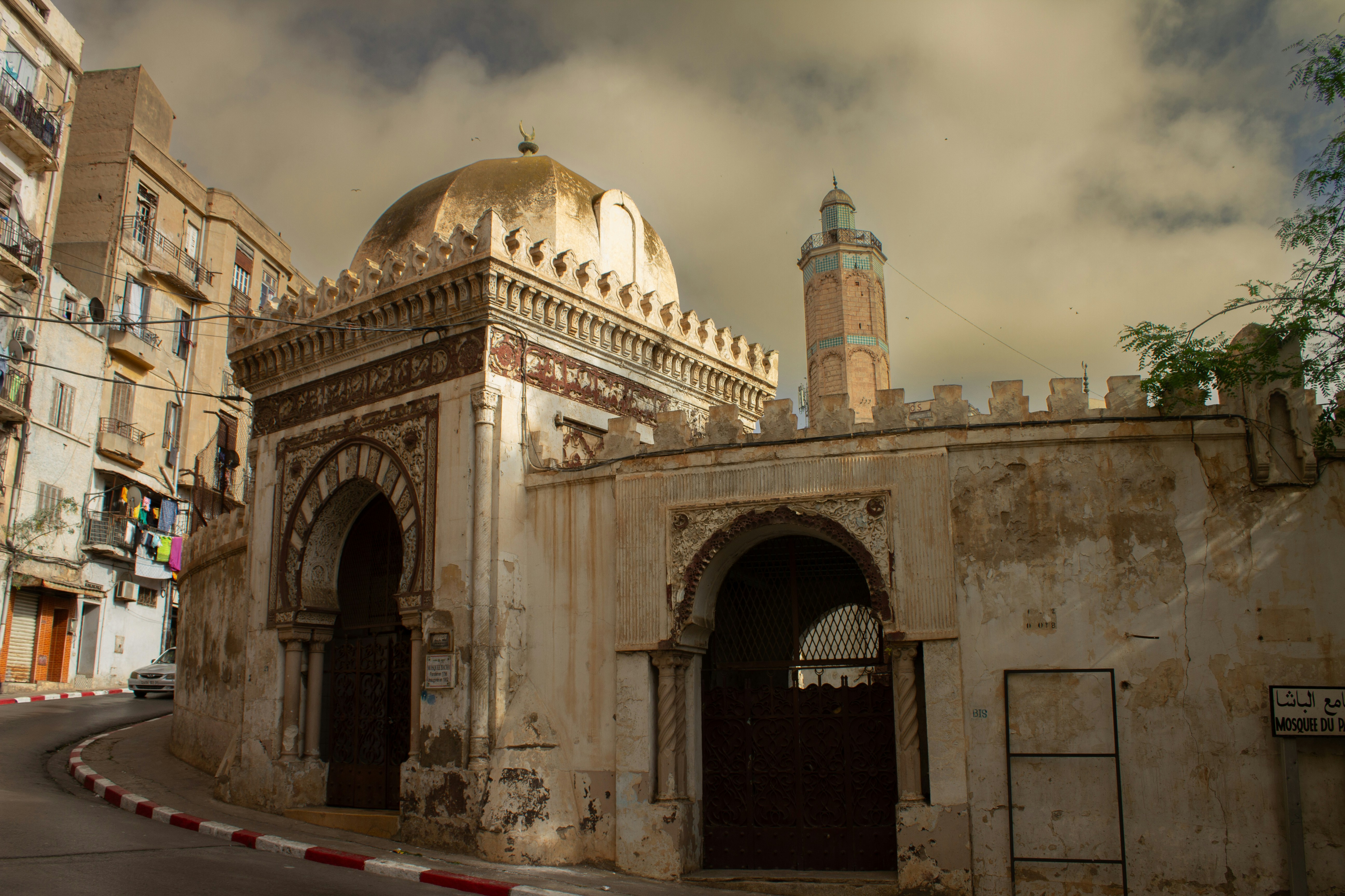 Weathered Portal: A Historic Arch Guarding the Quiet Street