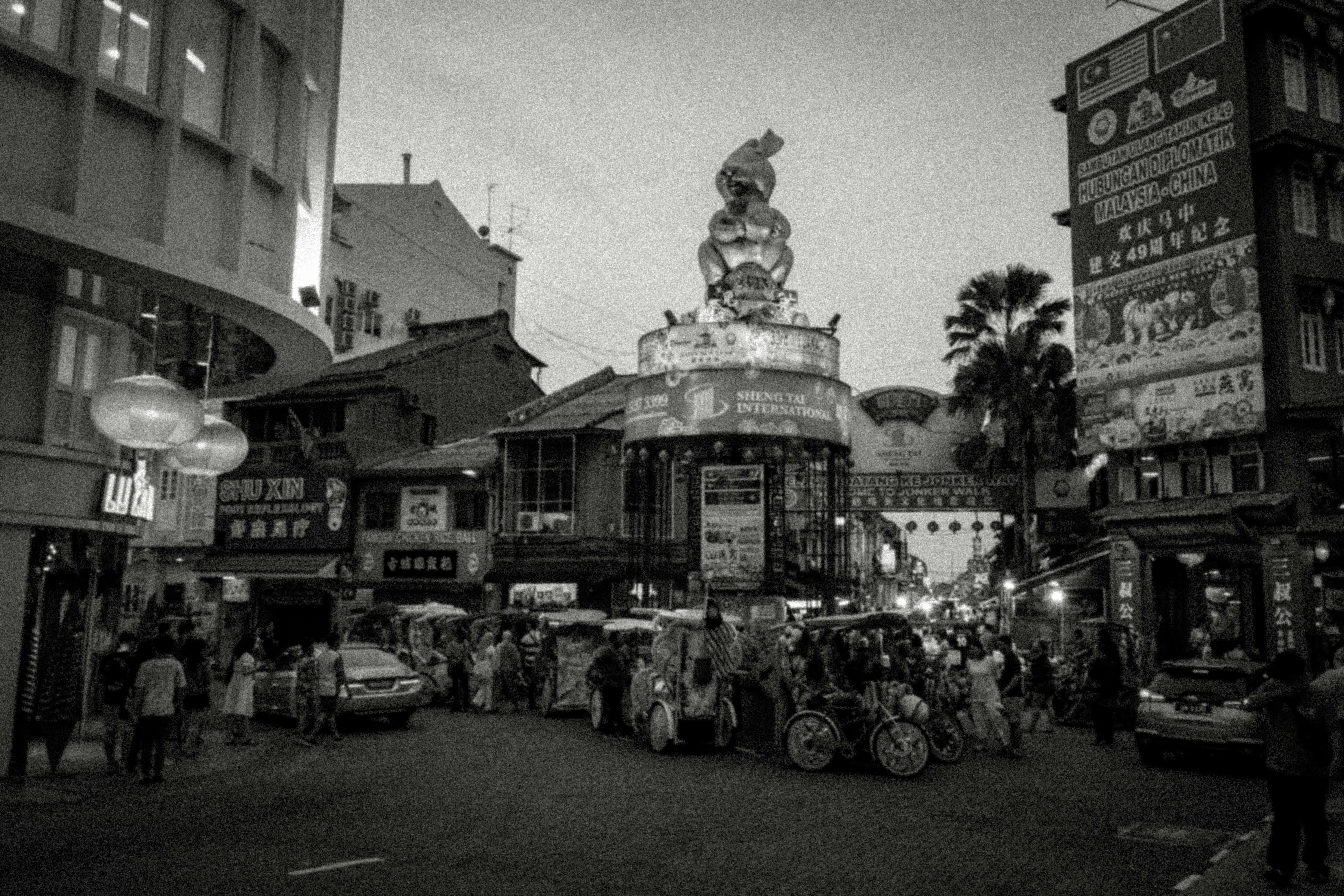 Street Gate at Dusk: A Bustling Night Market Centered Under Lanterns