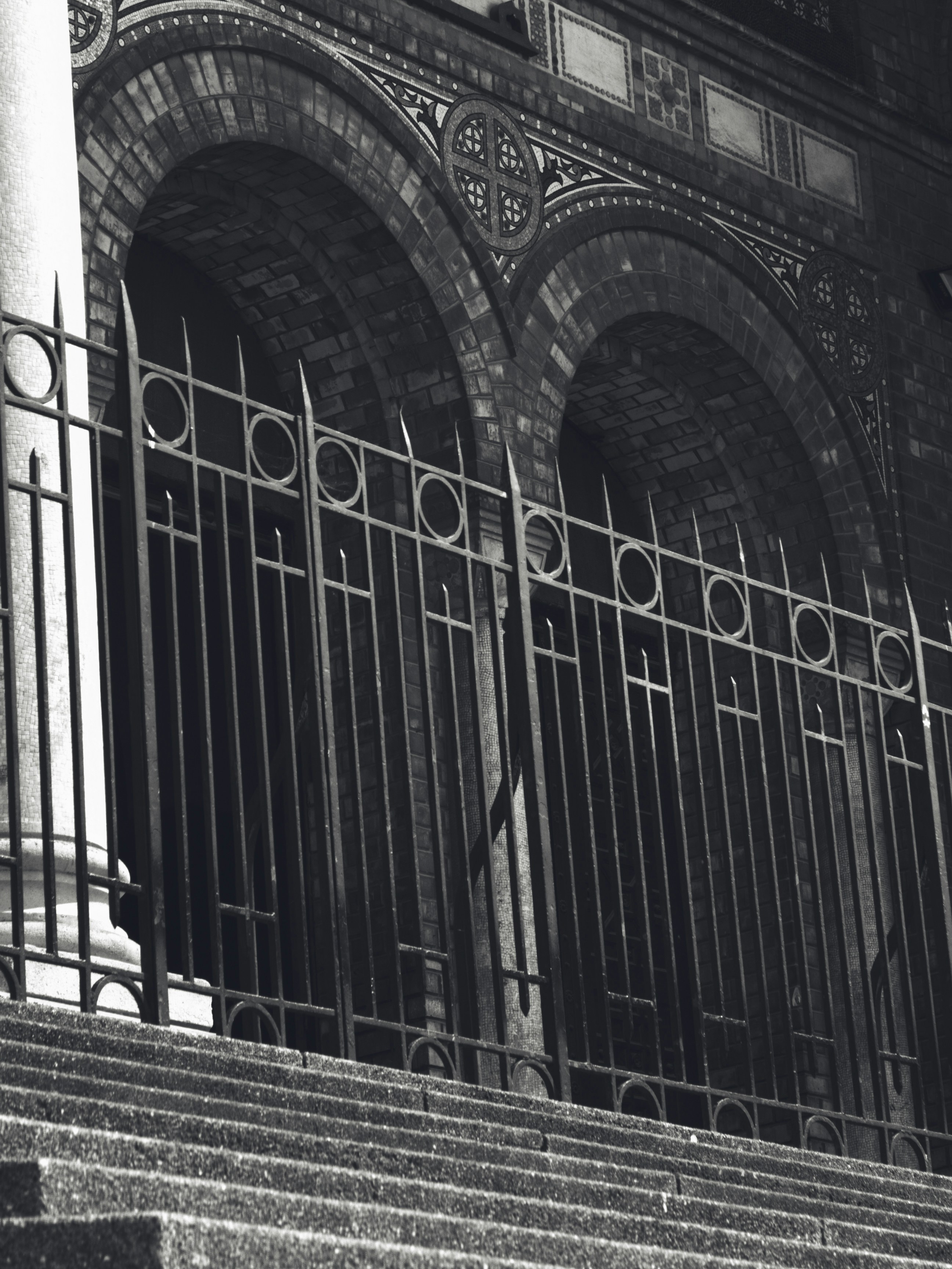 Iron Lattice and Arched Brickwork: A Quiet Staircase Moment