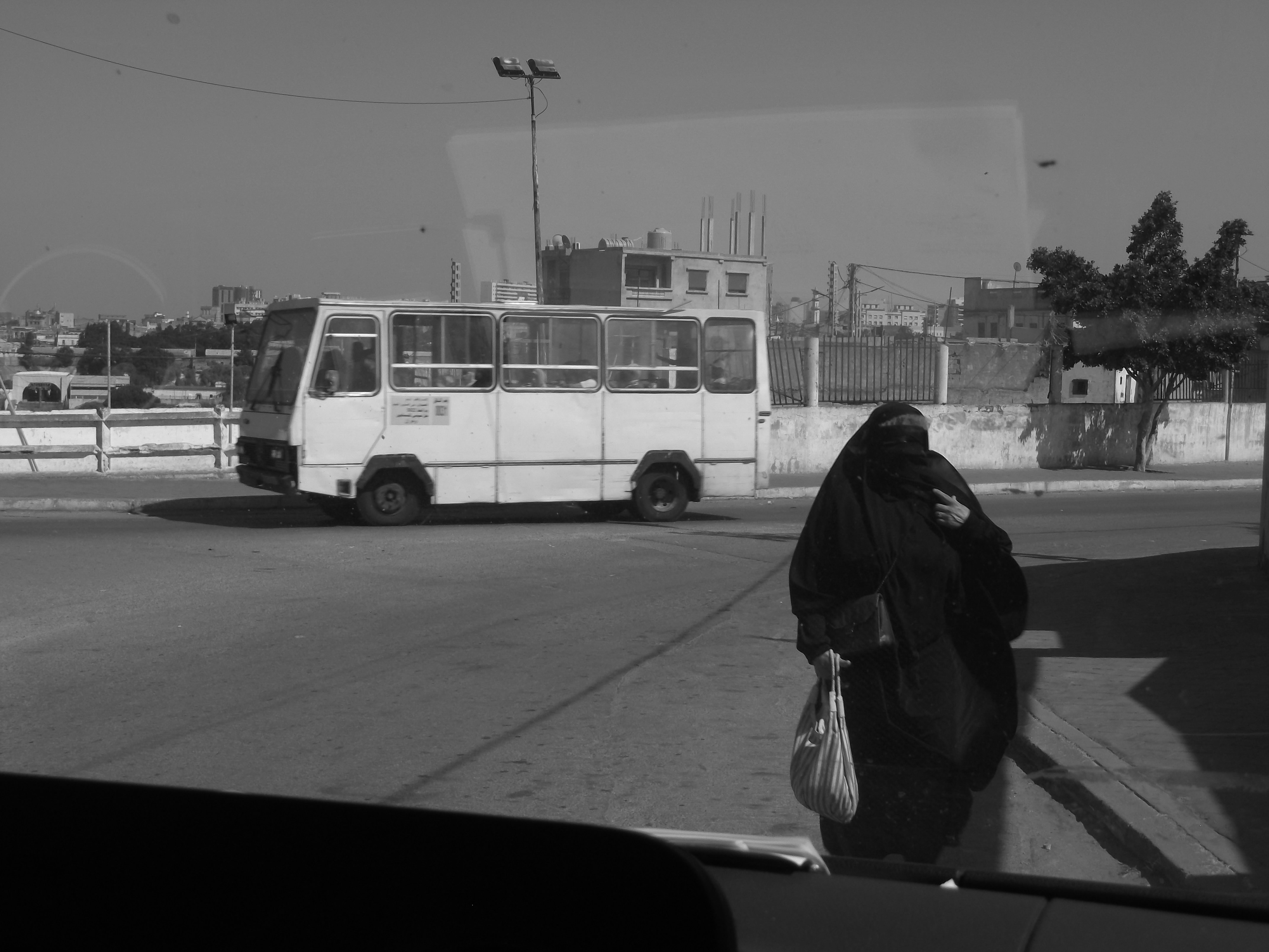 Street Crossing: A Lone Veil and a Distant Bus