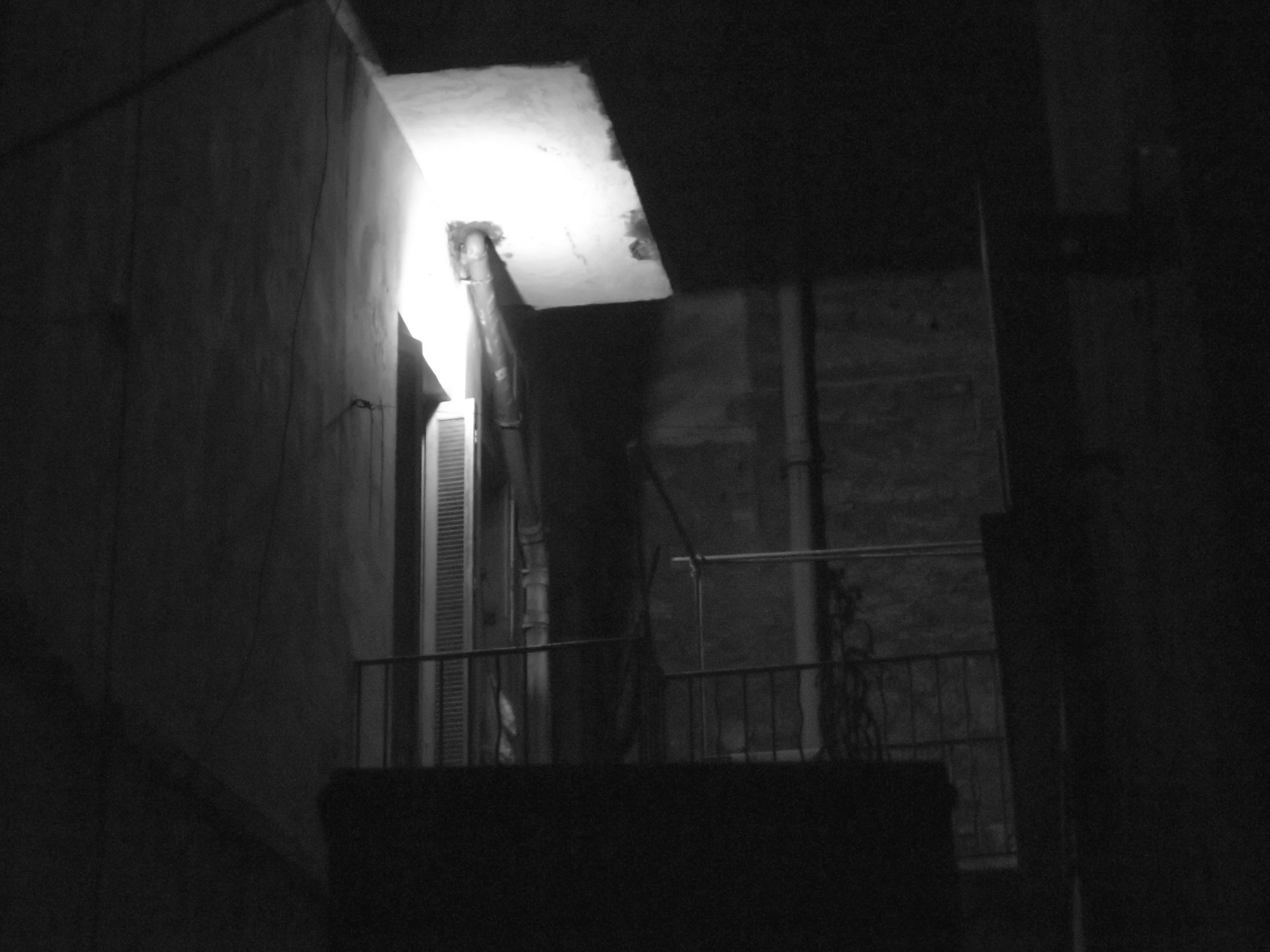 Bright light illuminates flowing water in a dark, industrial setting.