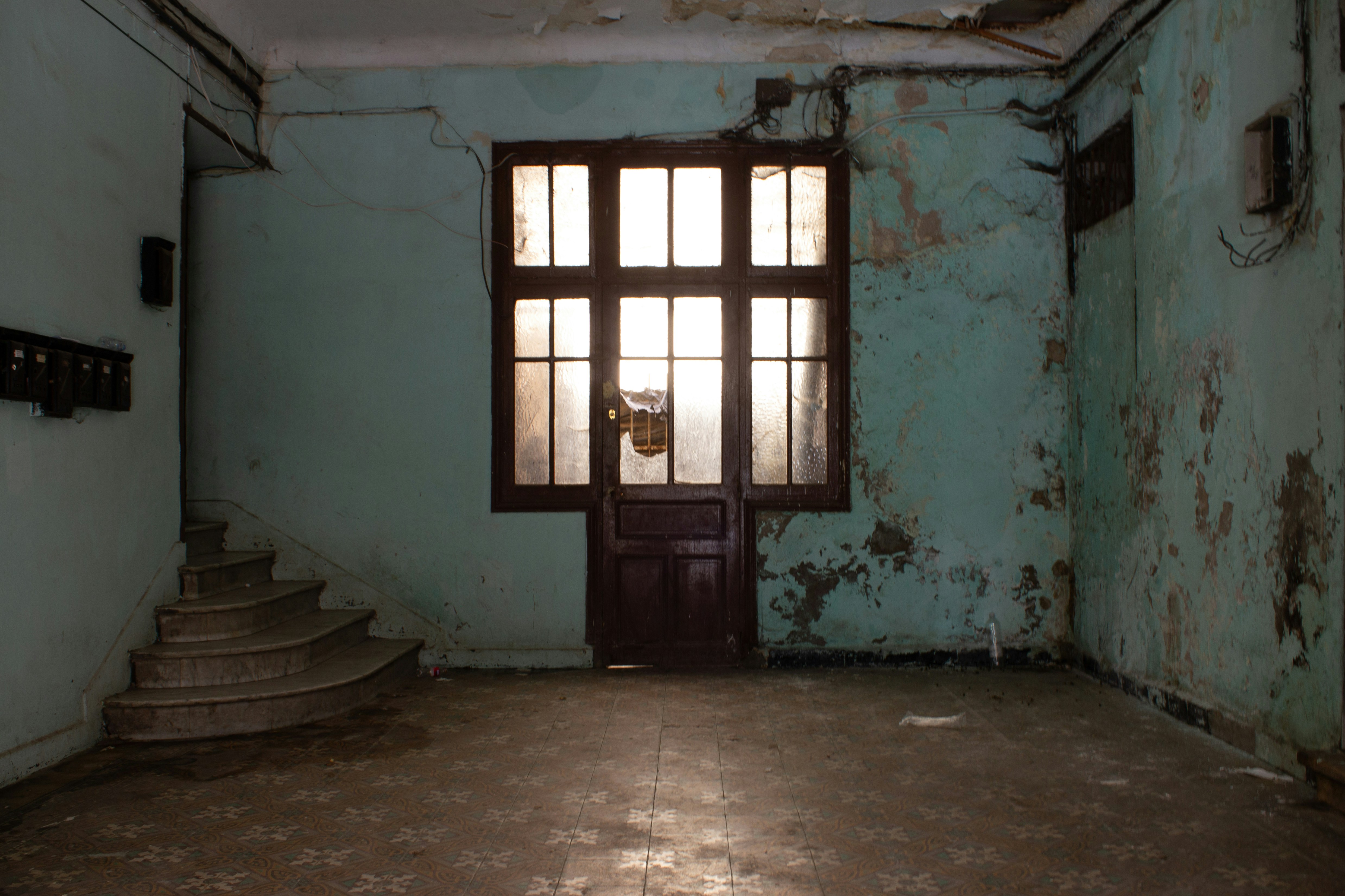 Abandoned Hallway: Light Through the Cracked Door