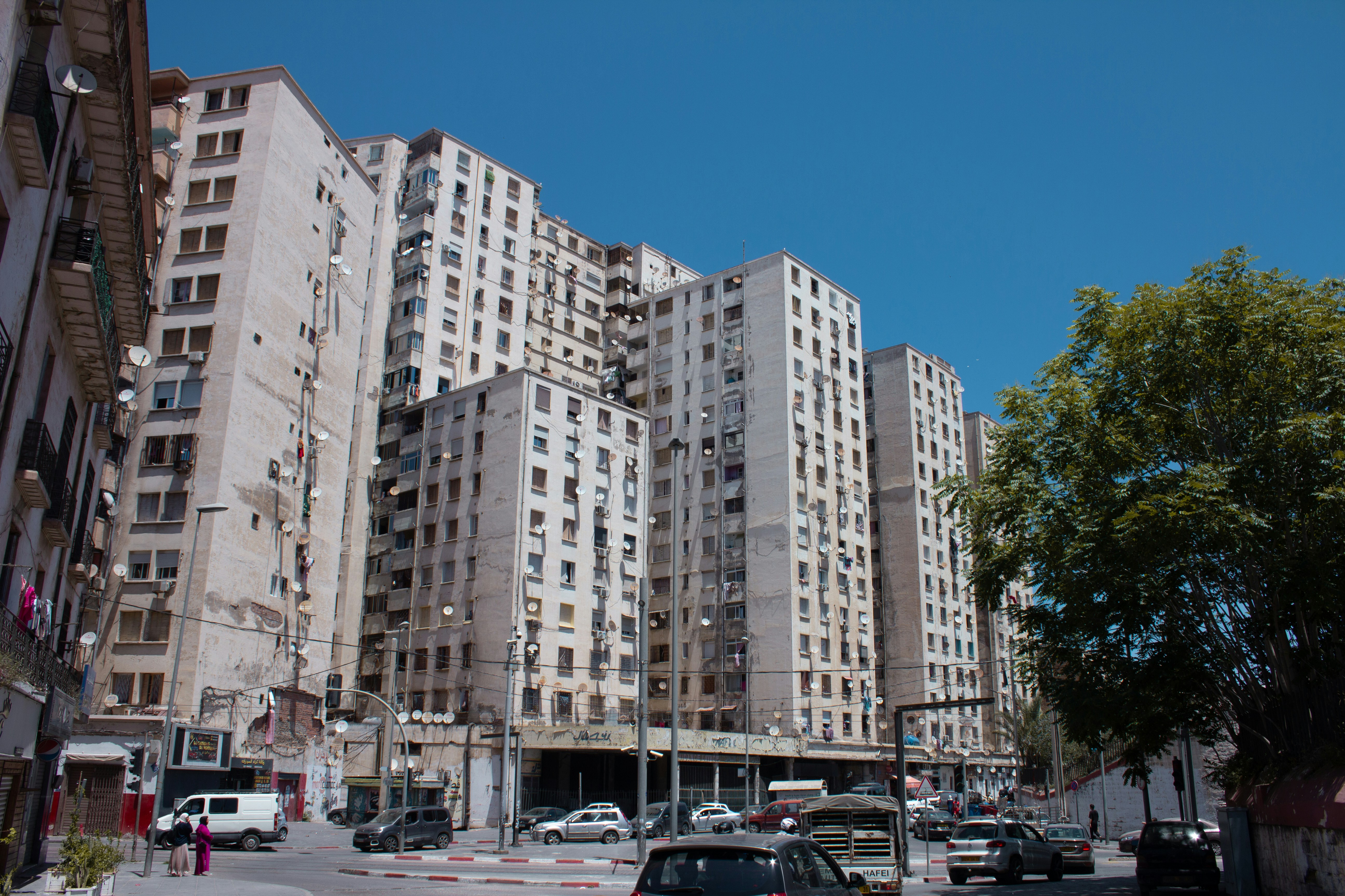 Concrete Skyline: A Sunlit Street Framed by Towering Apartments