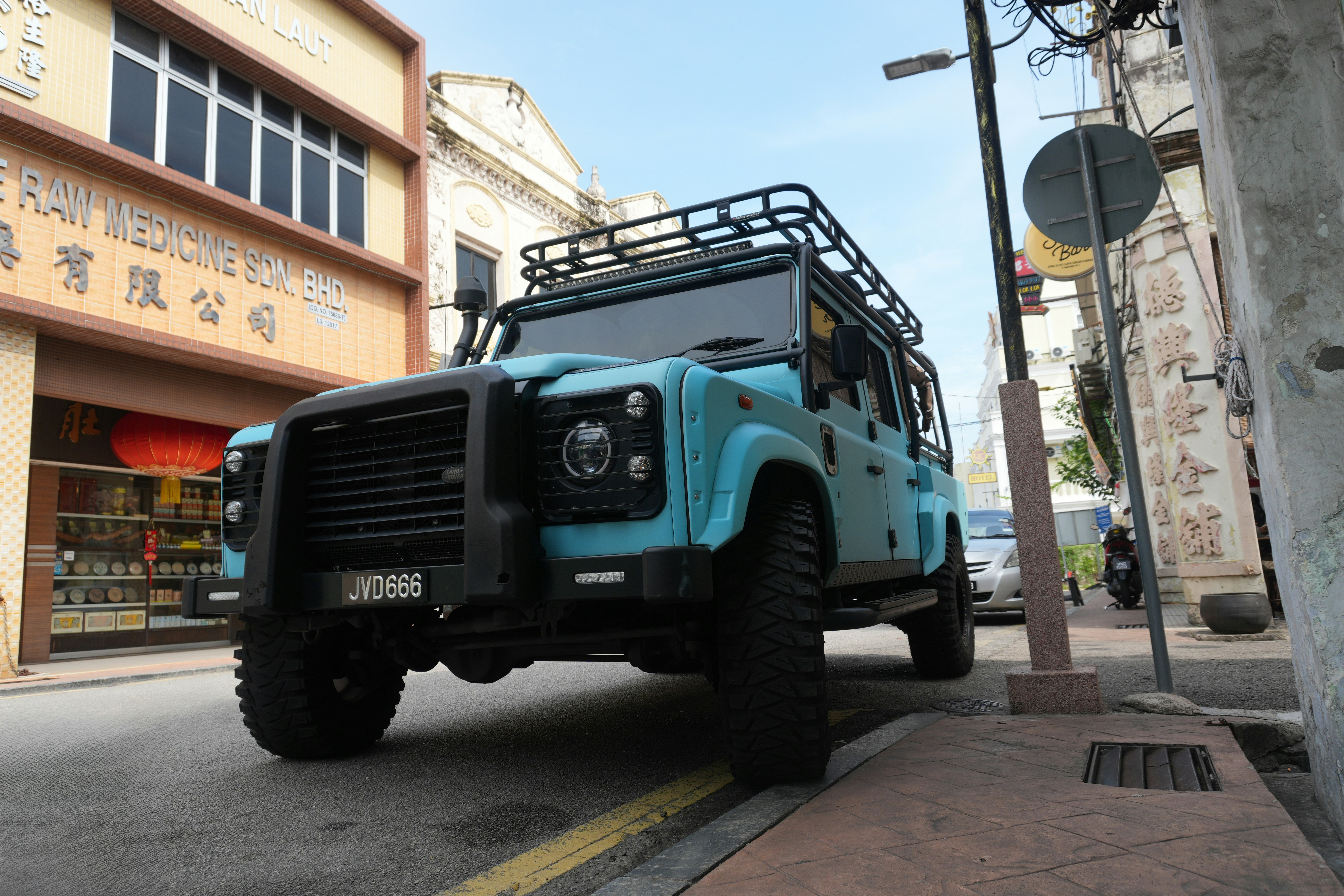 Rugged turquoise SUV Dominates a Urban Street Scene