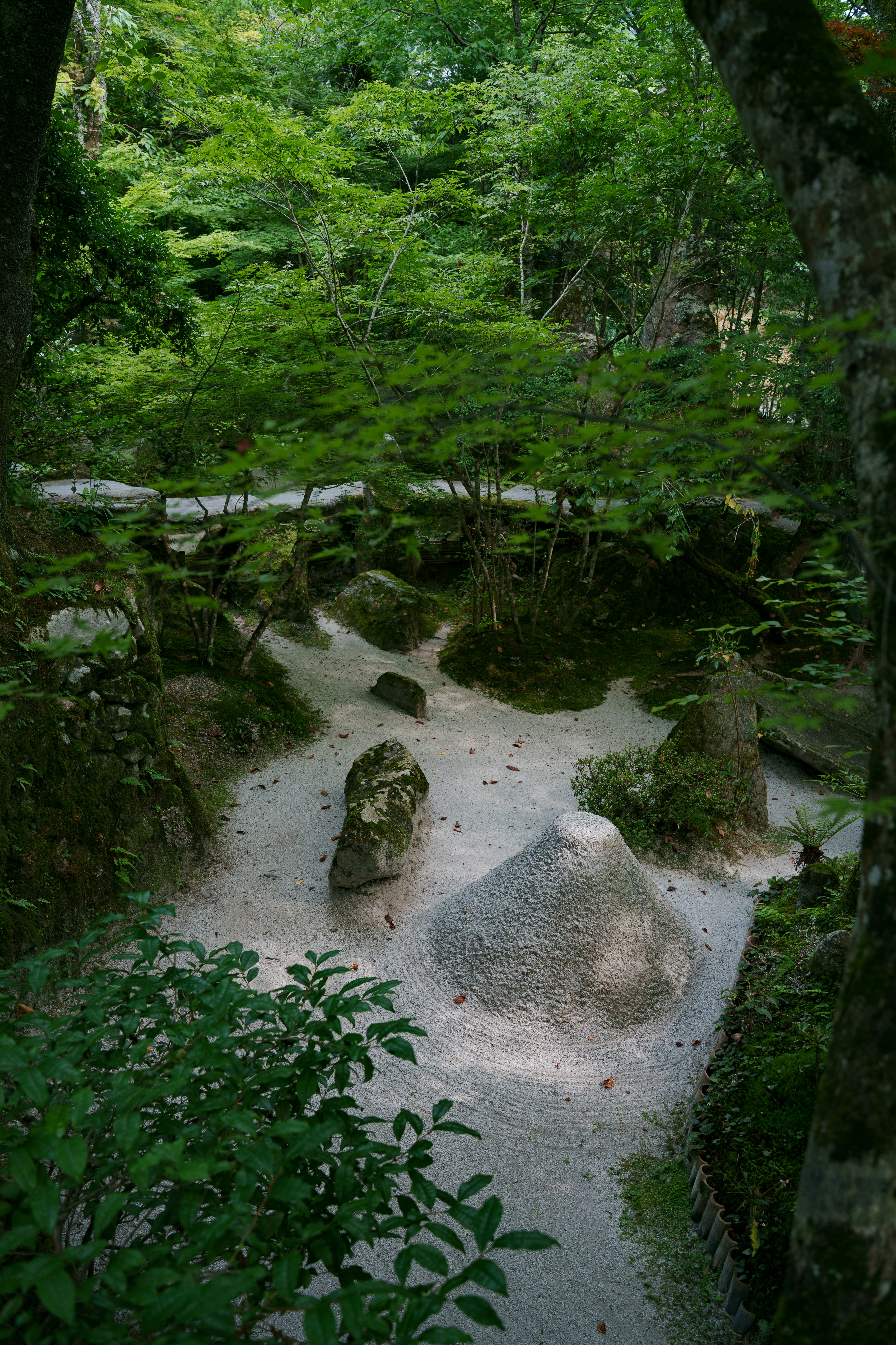 Raked Zen Stones and Sand in a Lush Japanese Garden