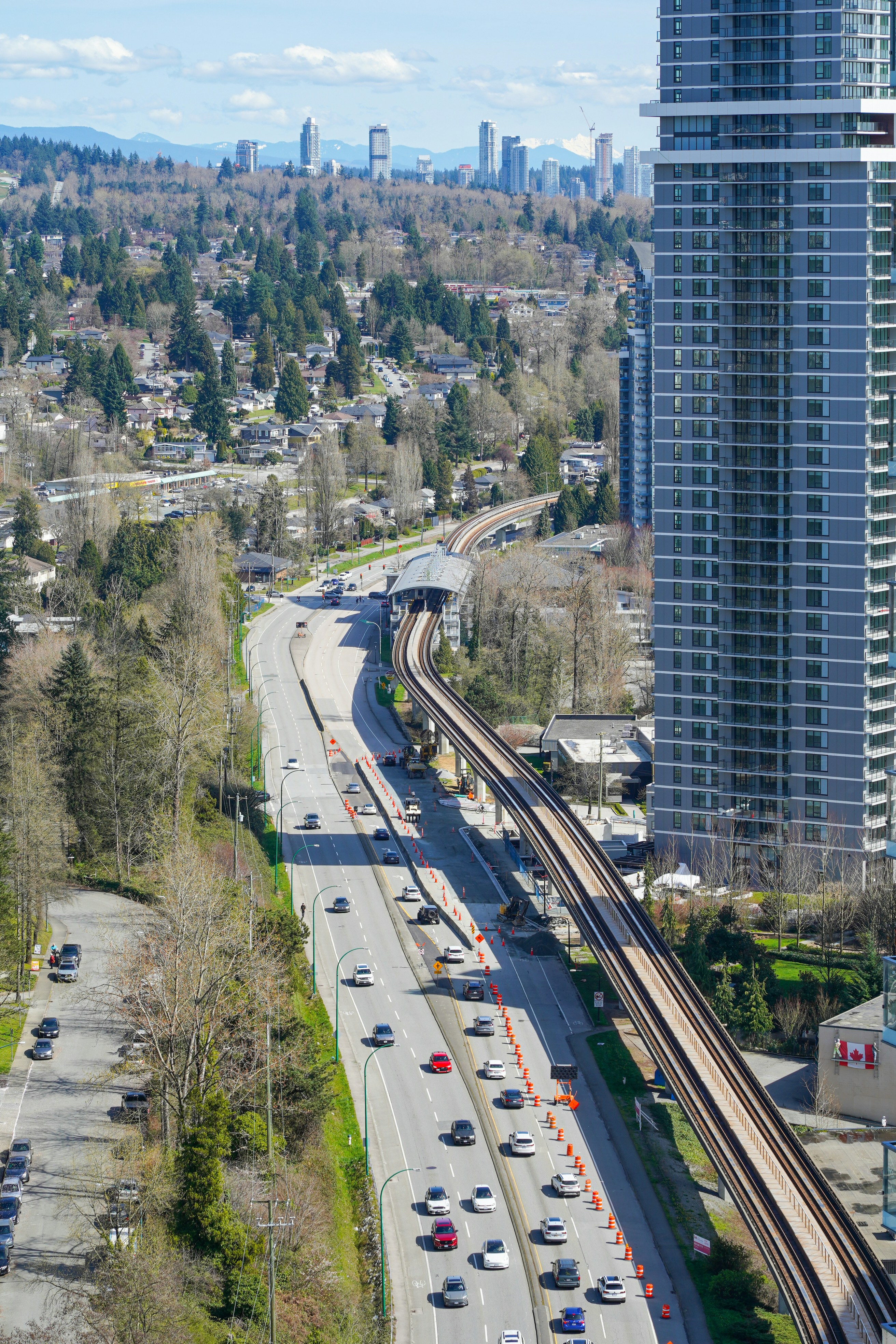 Urban Ribbon: A Highway Framed by Towers and Pines
