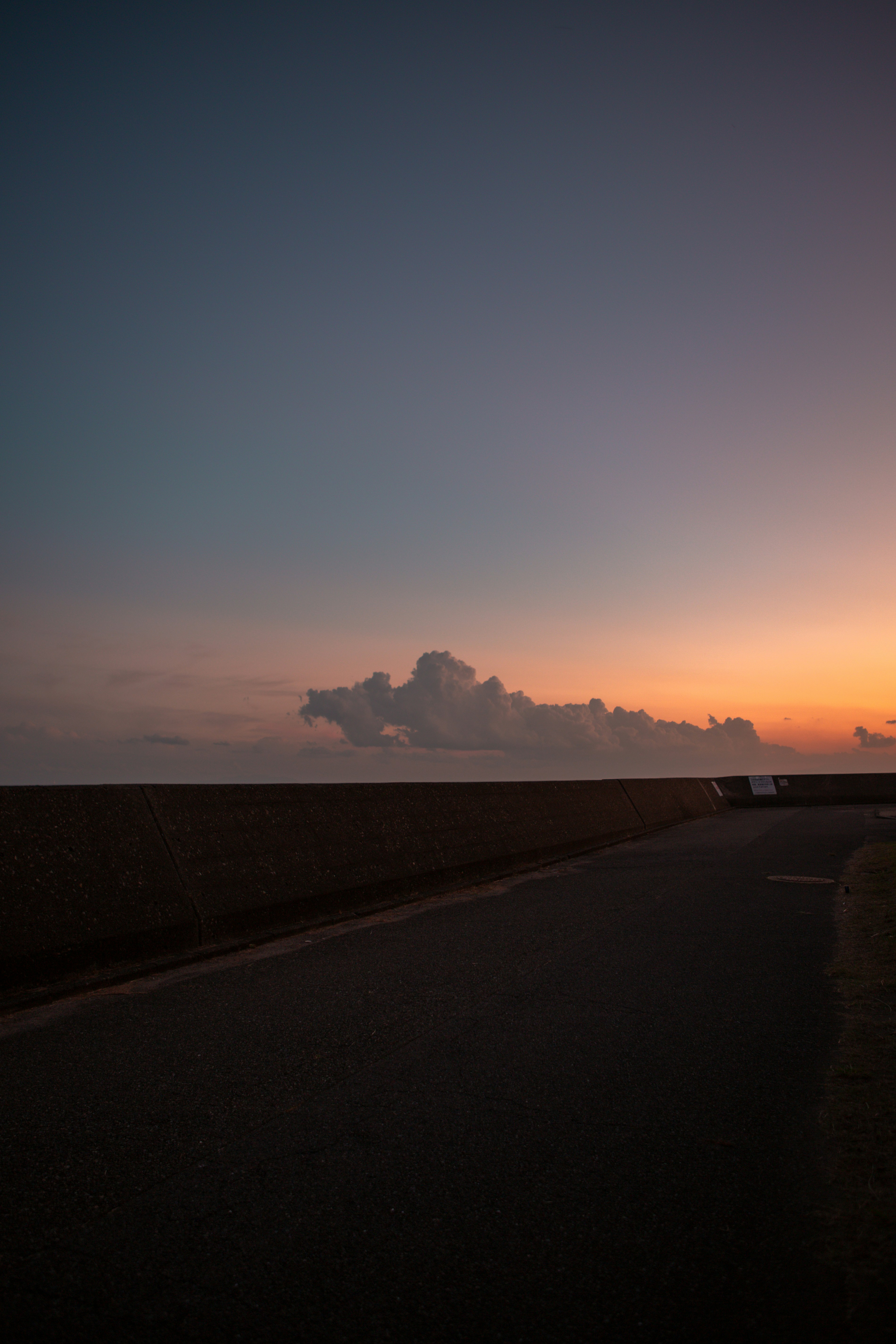 Sunset Transit: Quiet Sea-Sky Break Along a Distant Coastal Path