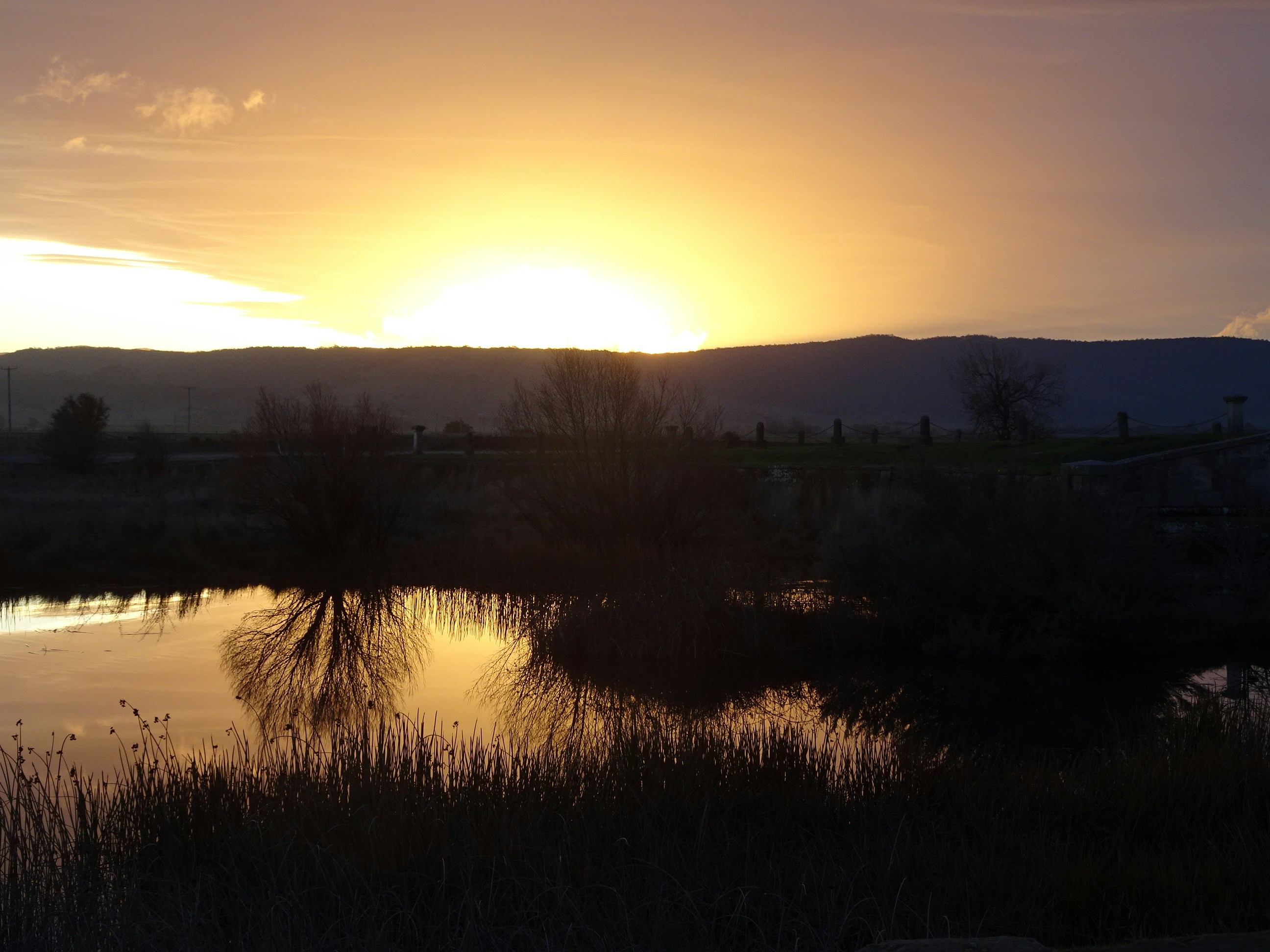 Dusk Over the Quiet Water: Sunset Reflections on a Prairie Bend