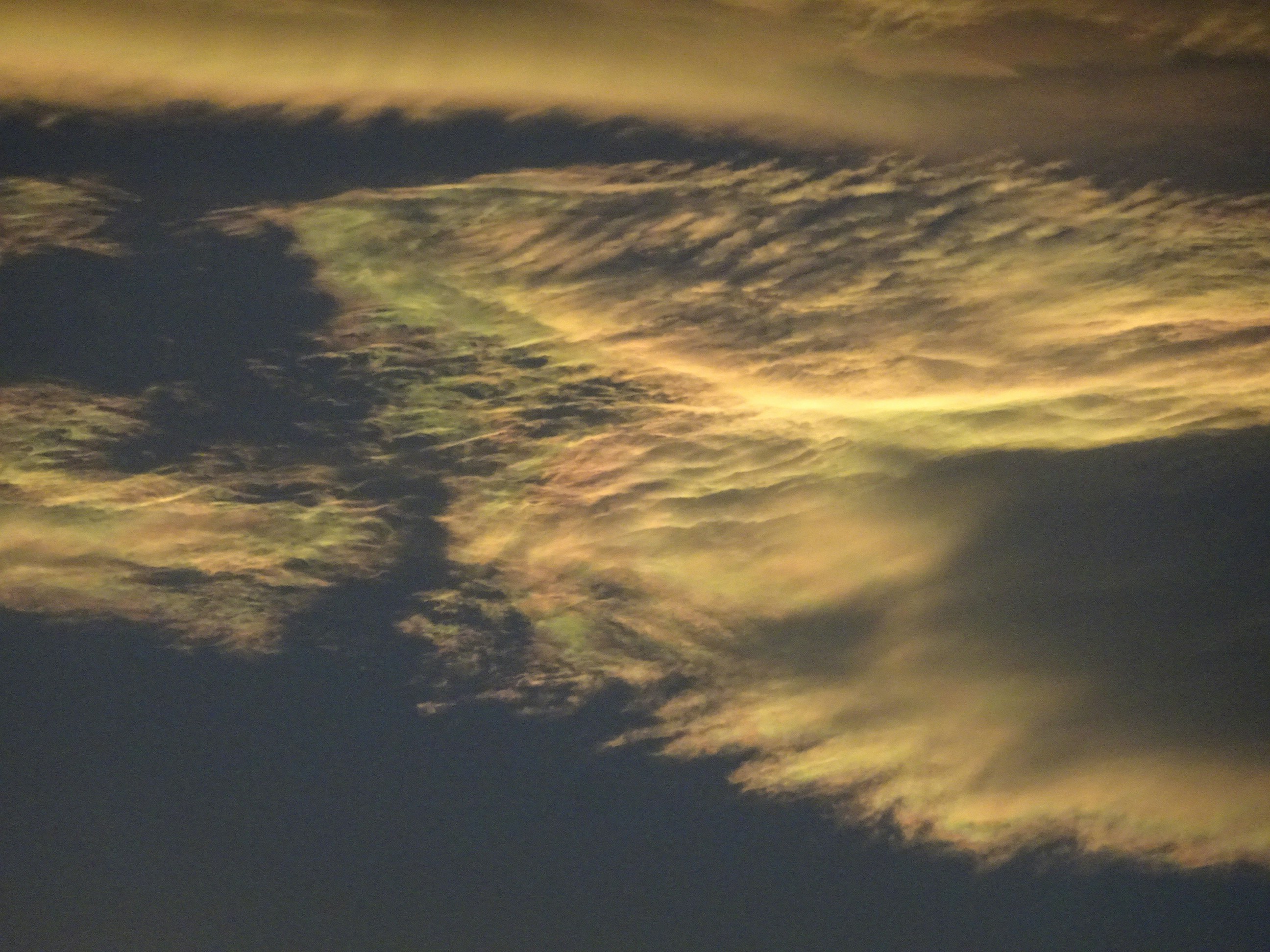 Golden Spreadeagles: High-Altitude Cloud Tapestry at Dusk