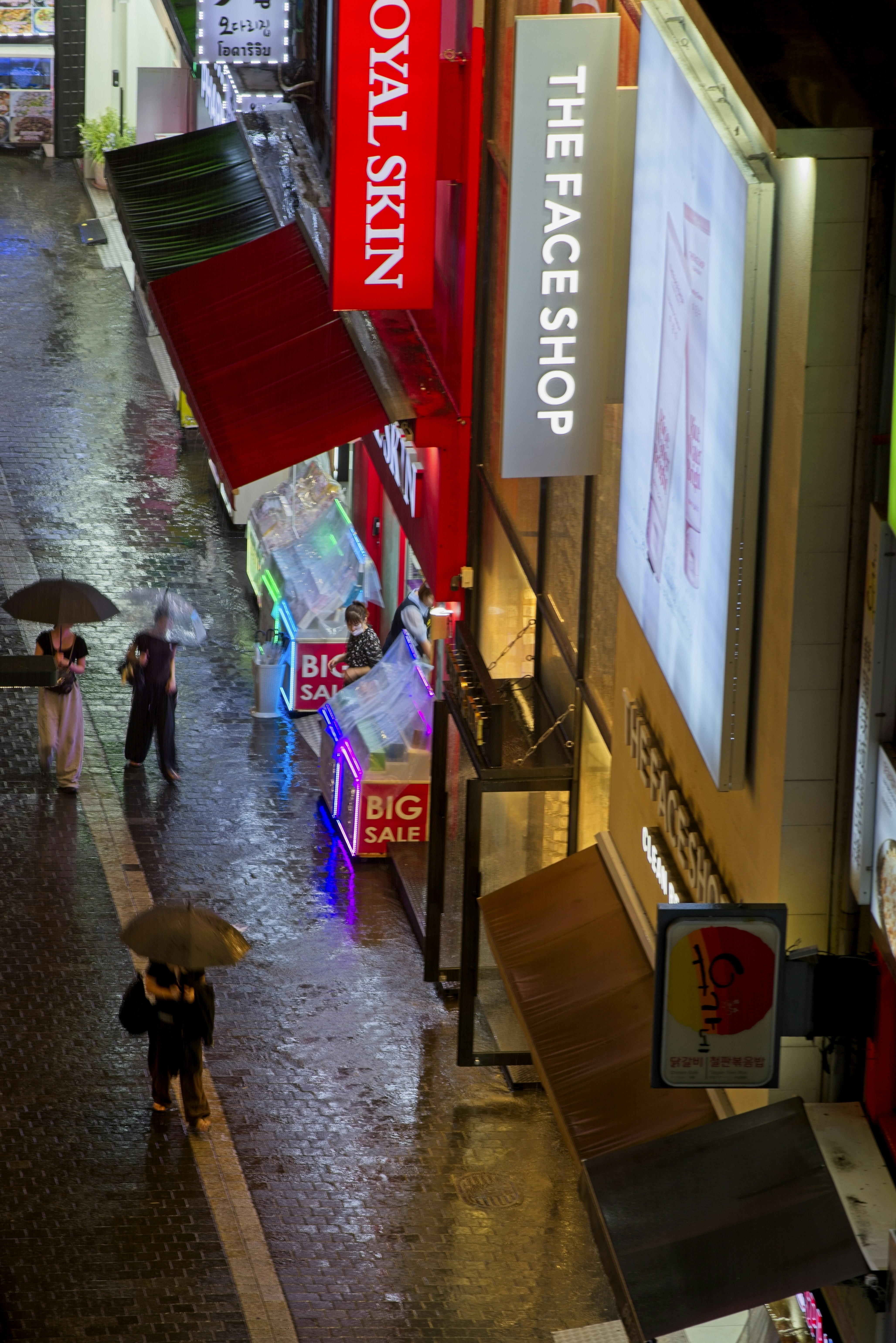Neon Alley: Rain, Reflections, and Retail Glow