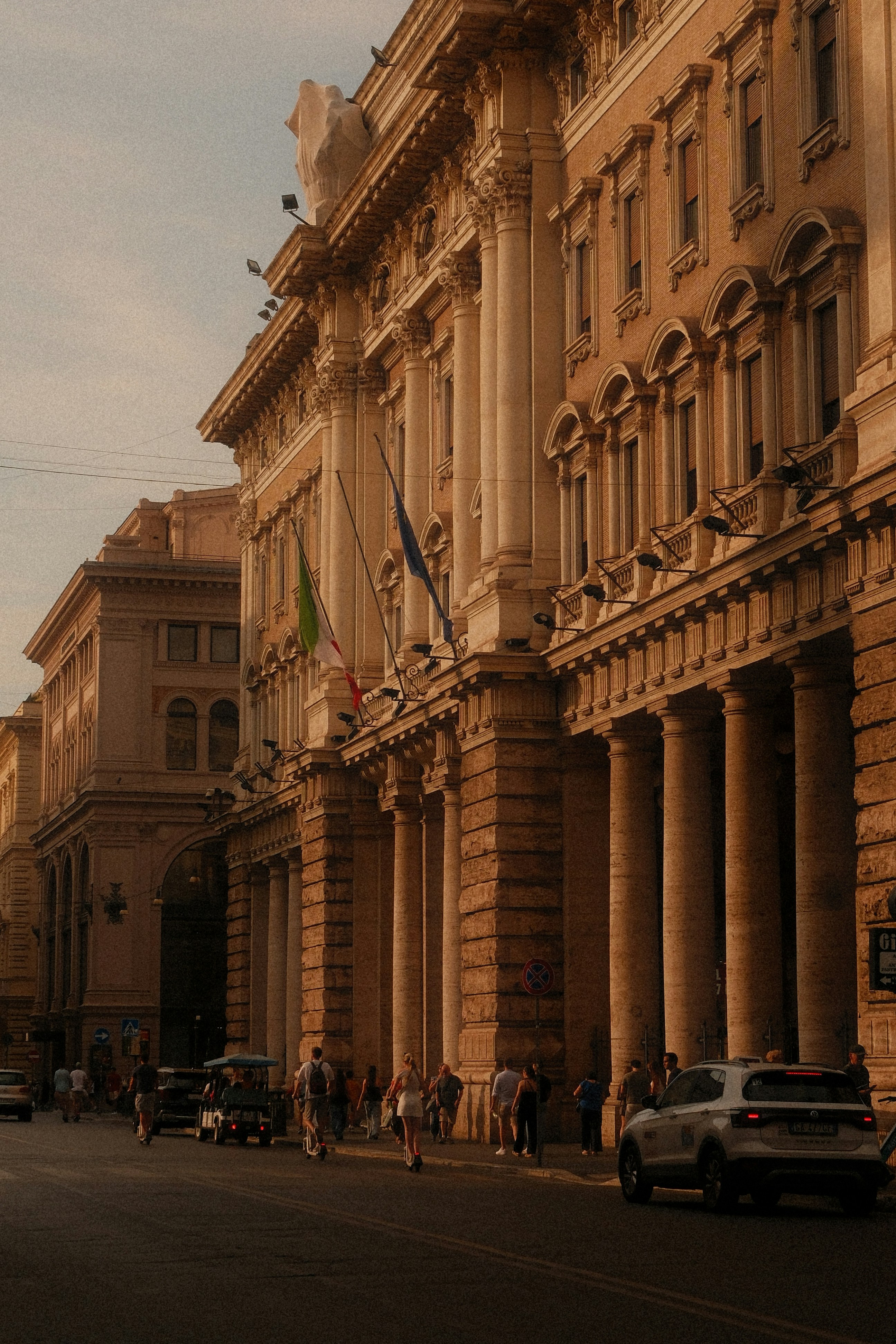 Grand Facade, Italy: Flags and Stone Columns at Dusk