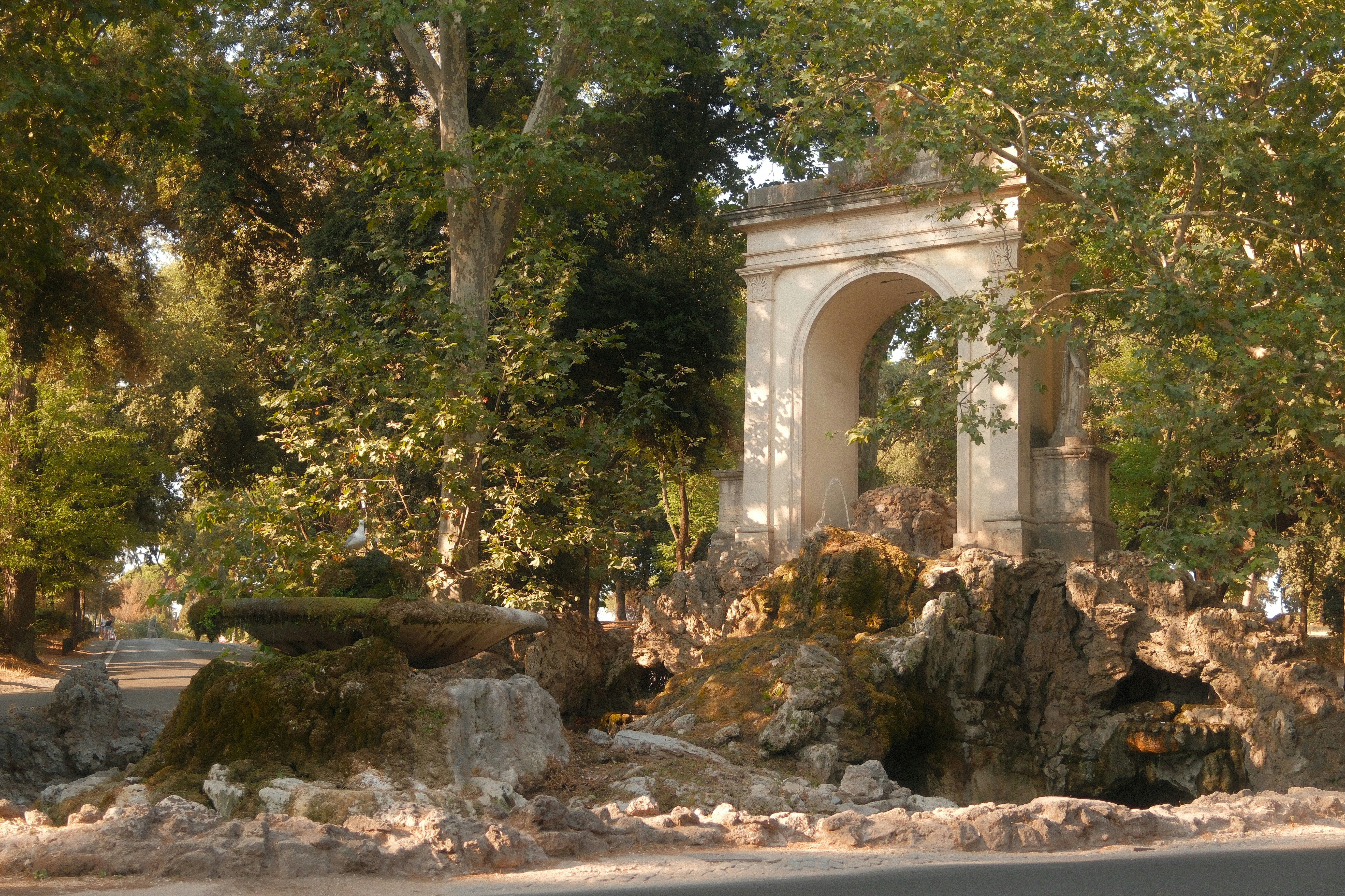Sunlit Arbor Arch Over rocky garden path