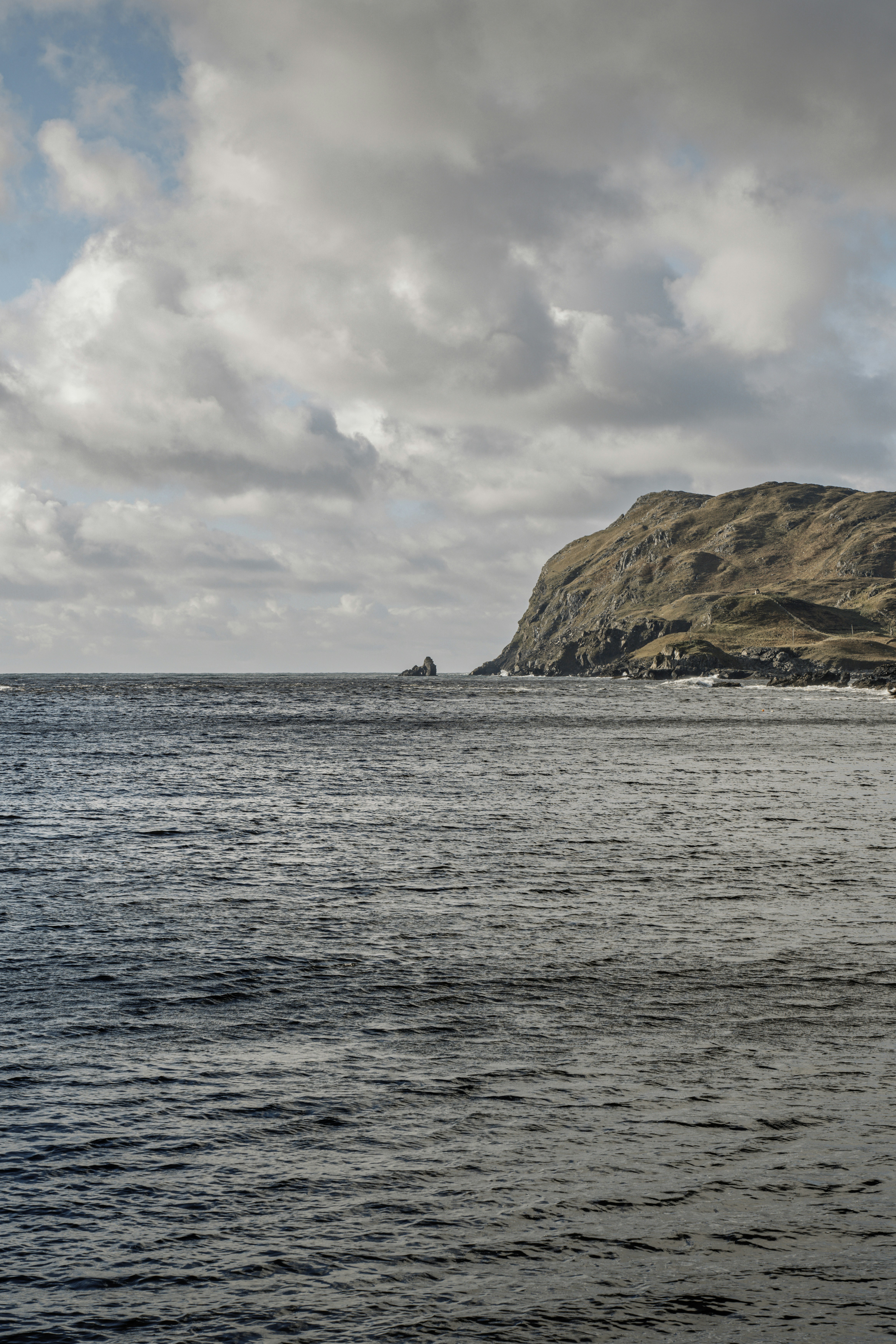 Coastal Ridge Meeting the Sea: Sunlit Cliffward Horizon