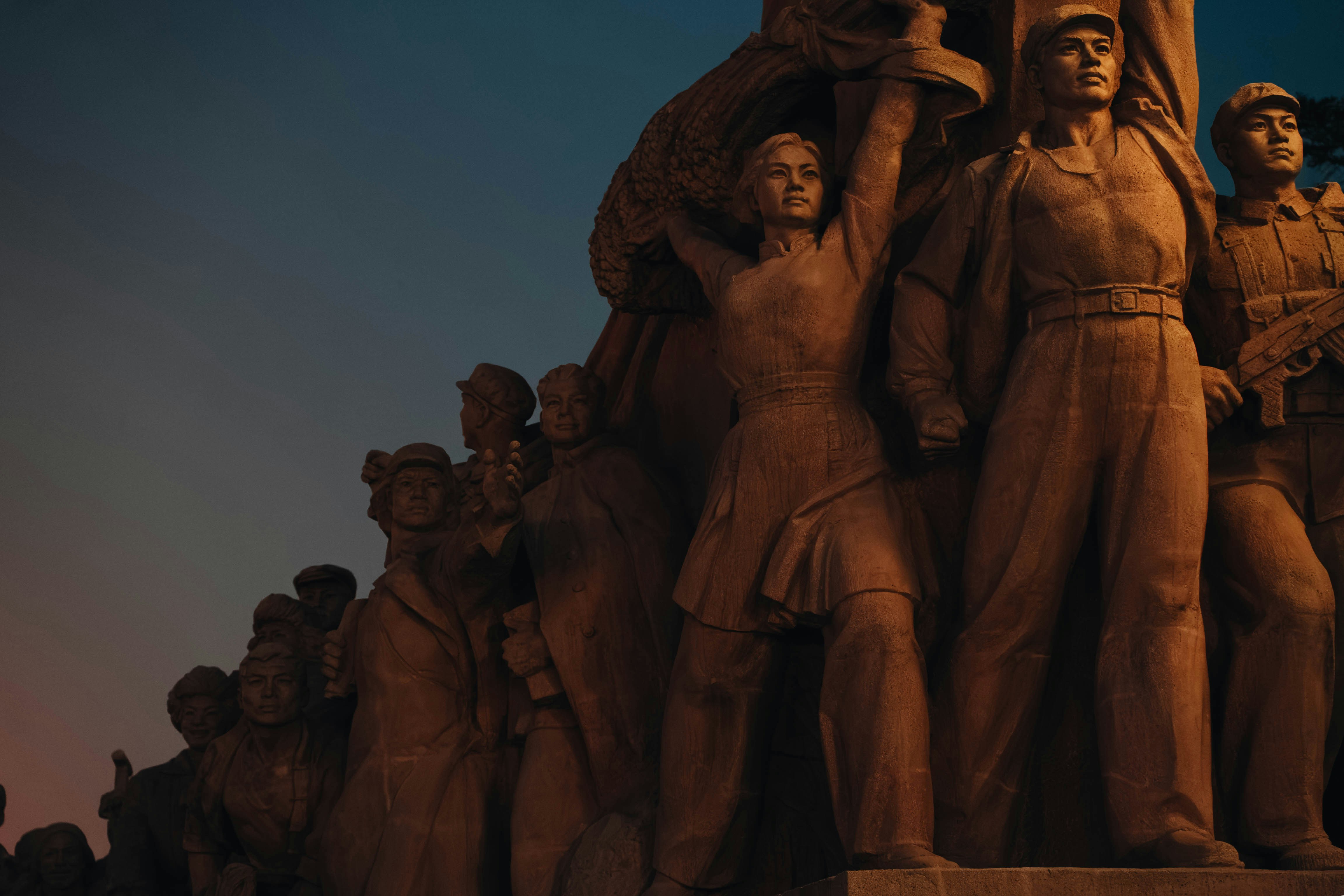 Stone Legion: a dawn-lit procession of monumental figures