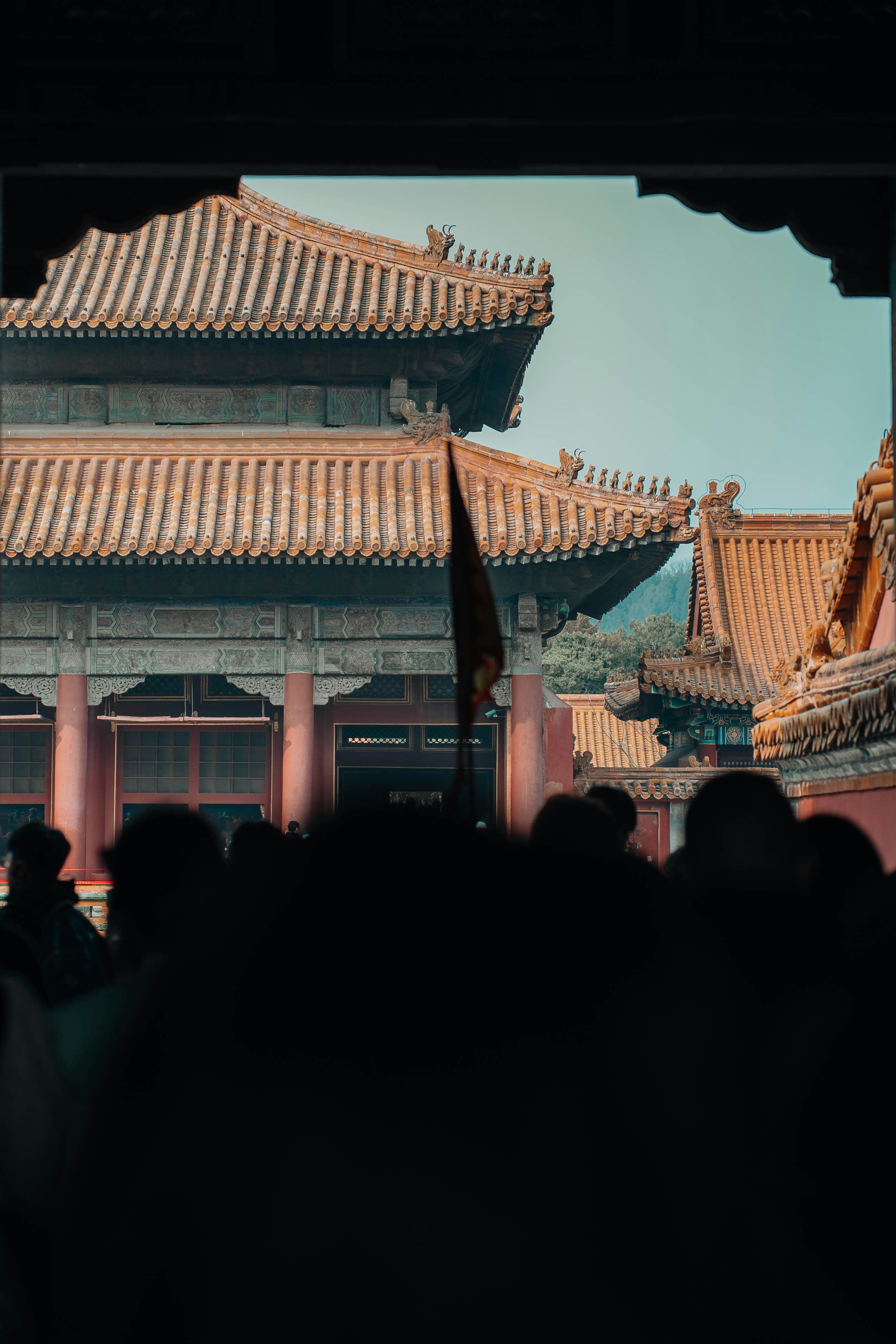 Courtyard of Quiet Giants: Ancient Roofs Framed by The Crowd