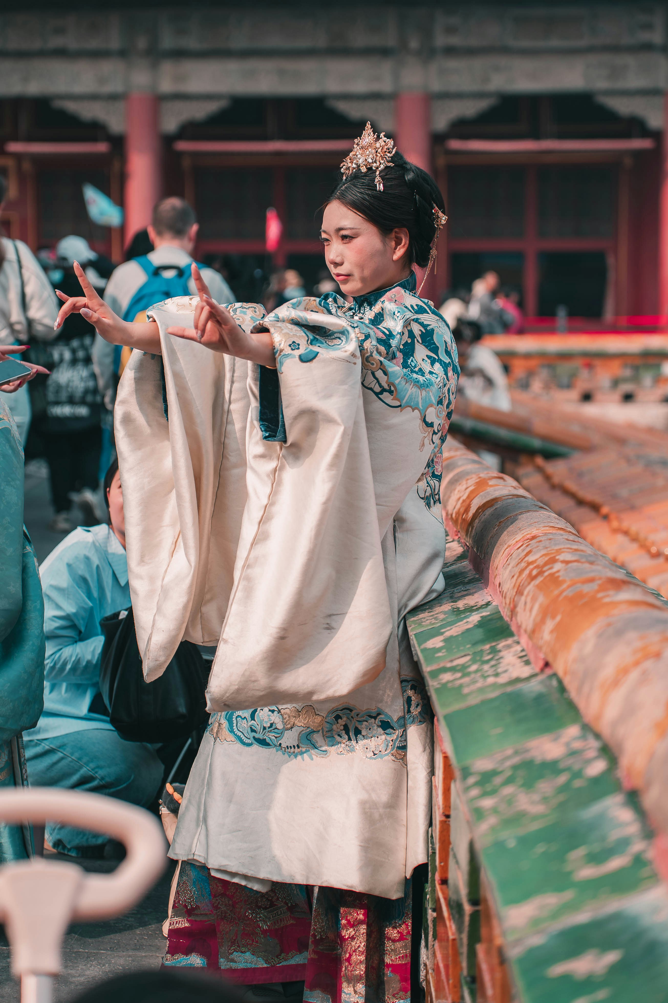 Elegance in Motion: A Traditional Attire Performer Reaches Toward the Crowd