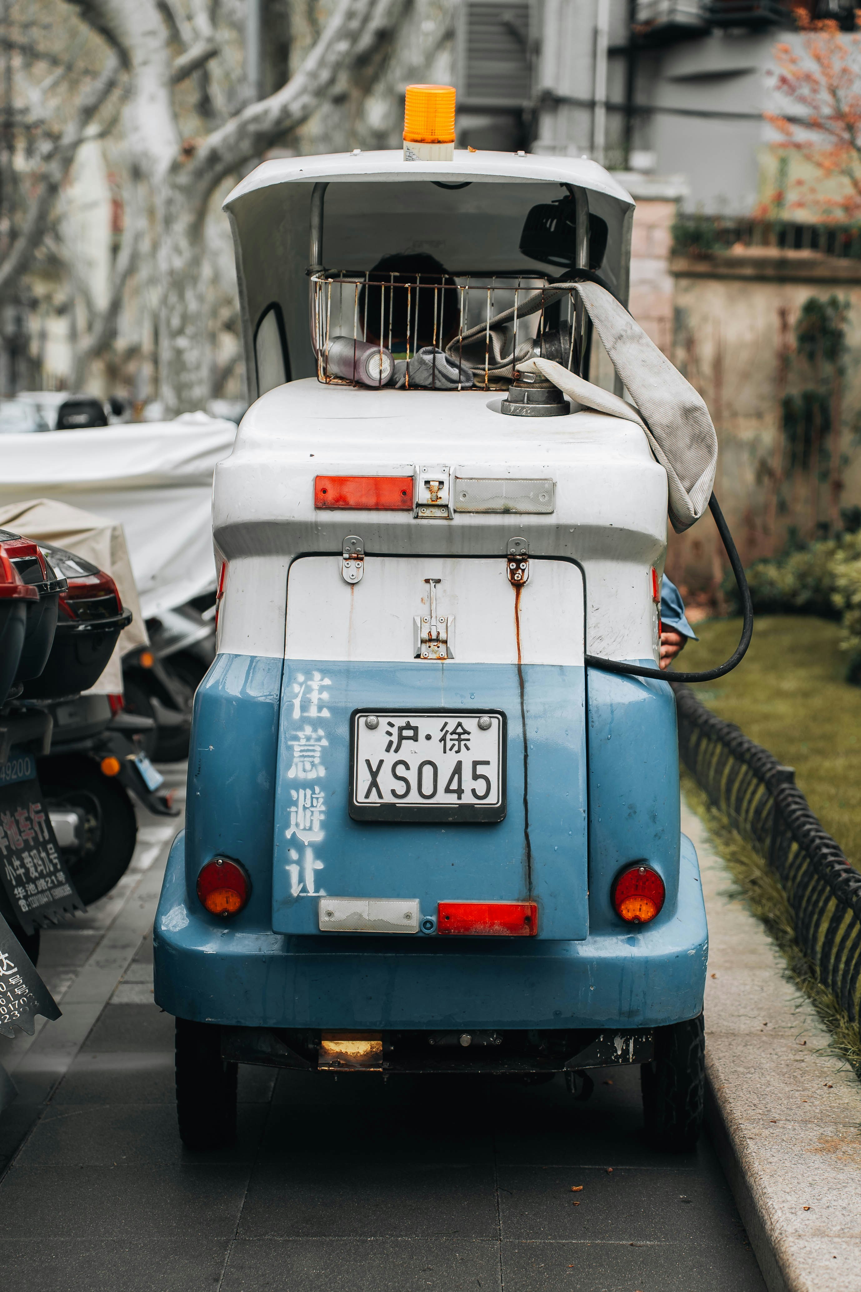 Tail of the City: A Quiet Refueling Scene on a Vintage Scooter