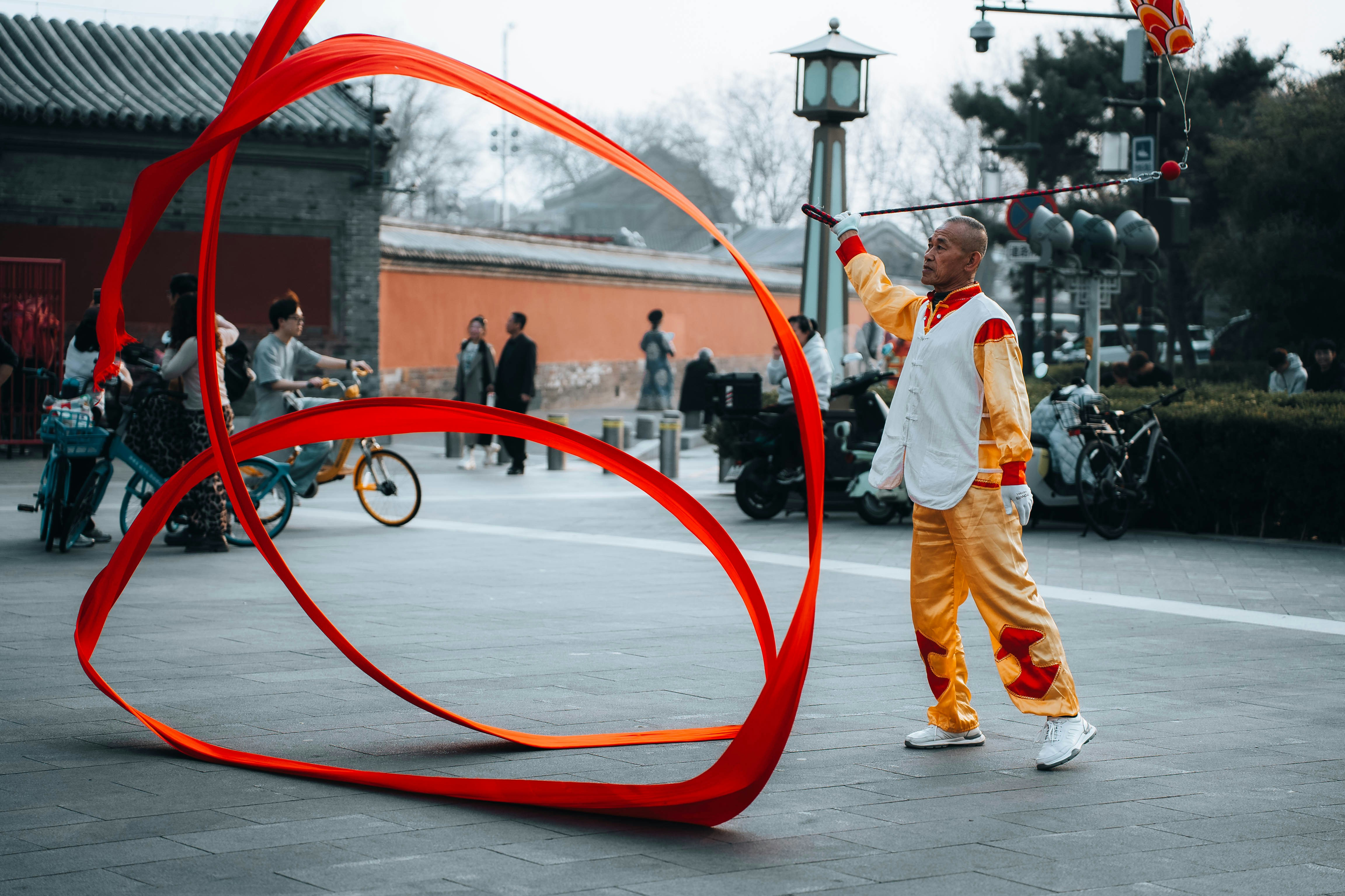 Red Ribbon in Motion: A Street Performer Spins Color and Light