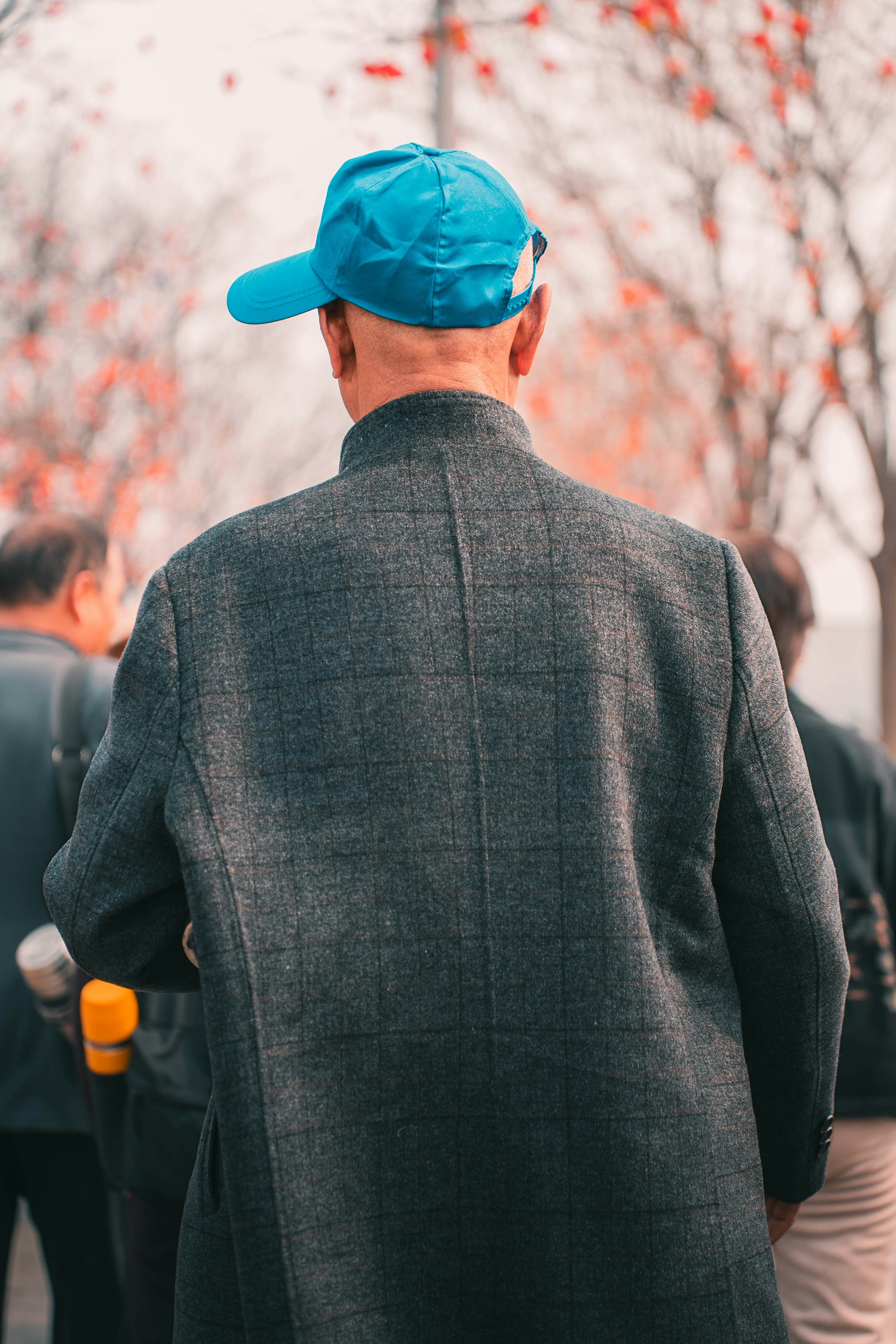 Blue Cap, Grey Coat, and a City Backdrop