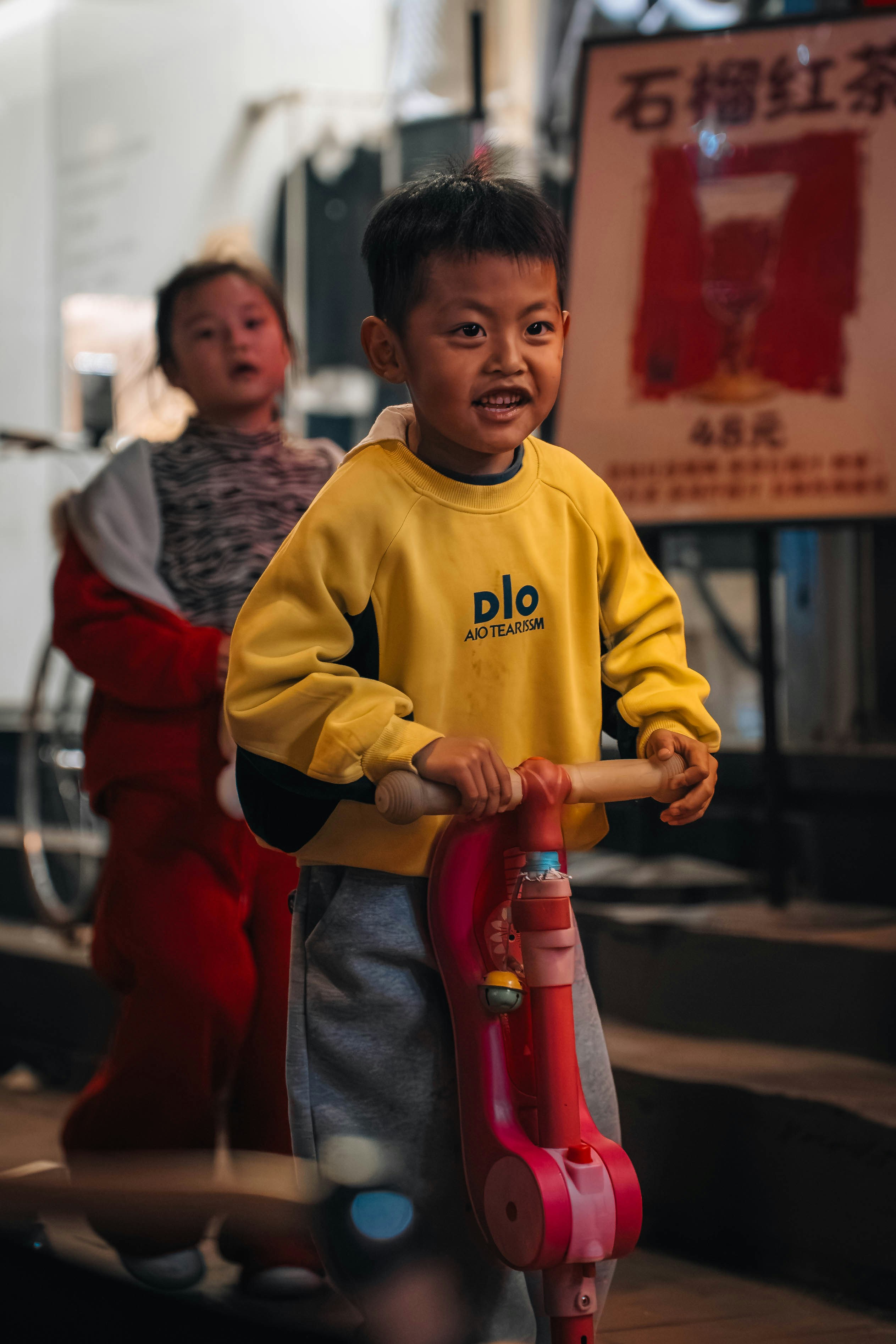 Joyful Pedal Rush: A Little Rider Leads the Street