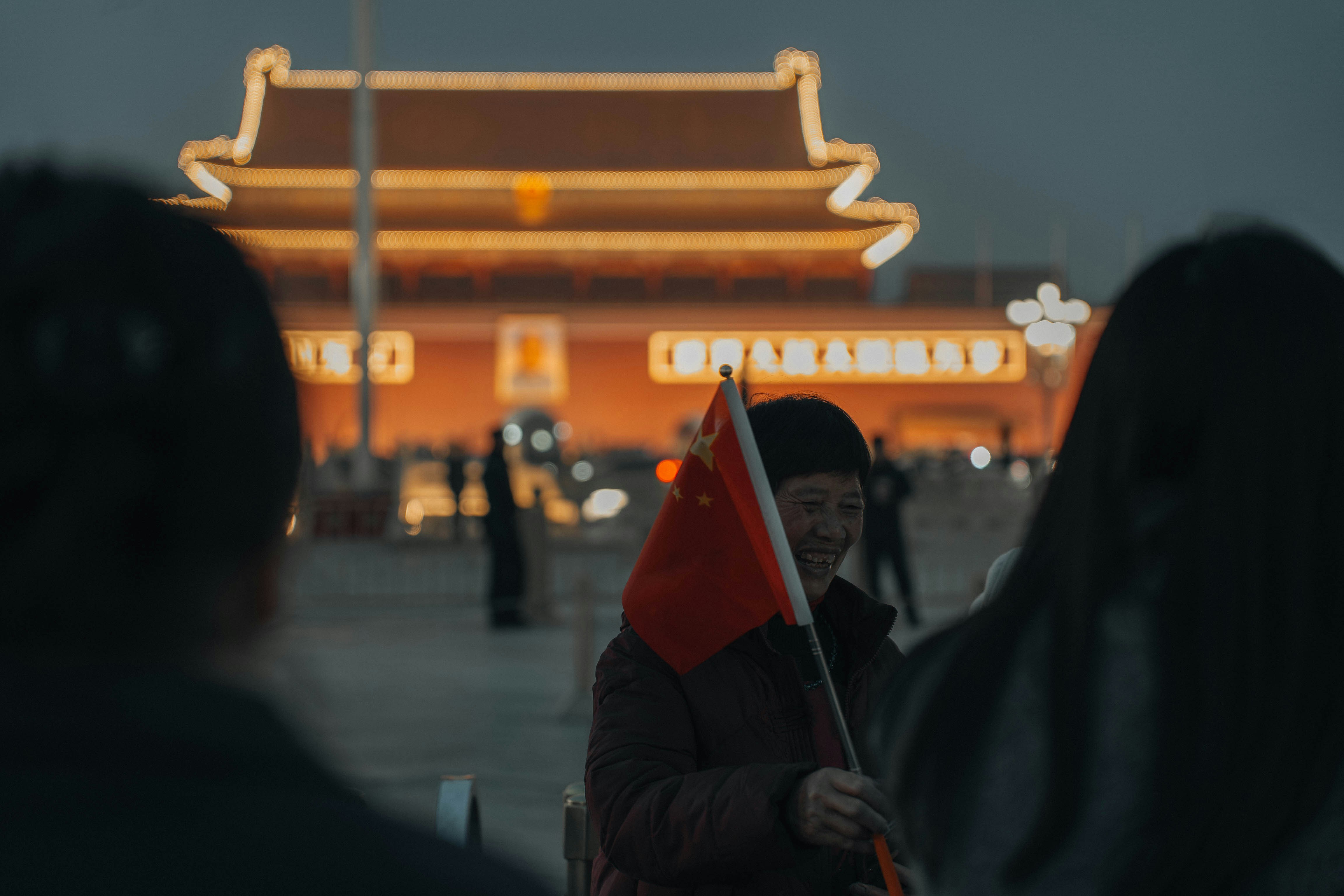 Flag in Focus: A smile between silhouettes beneath lantern-lit gates