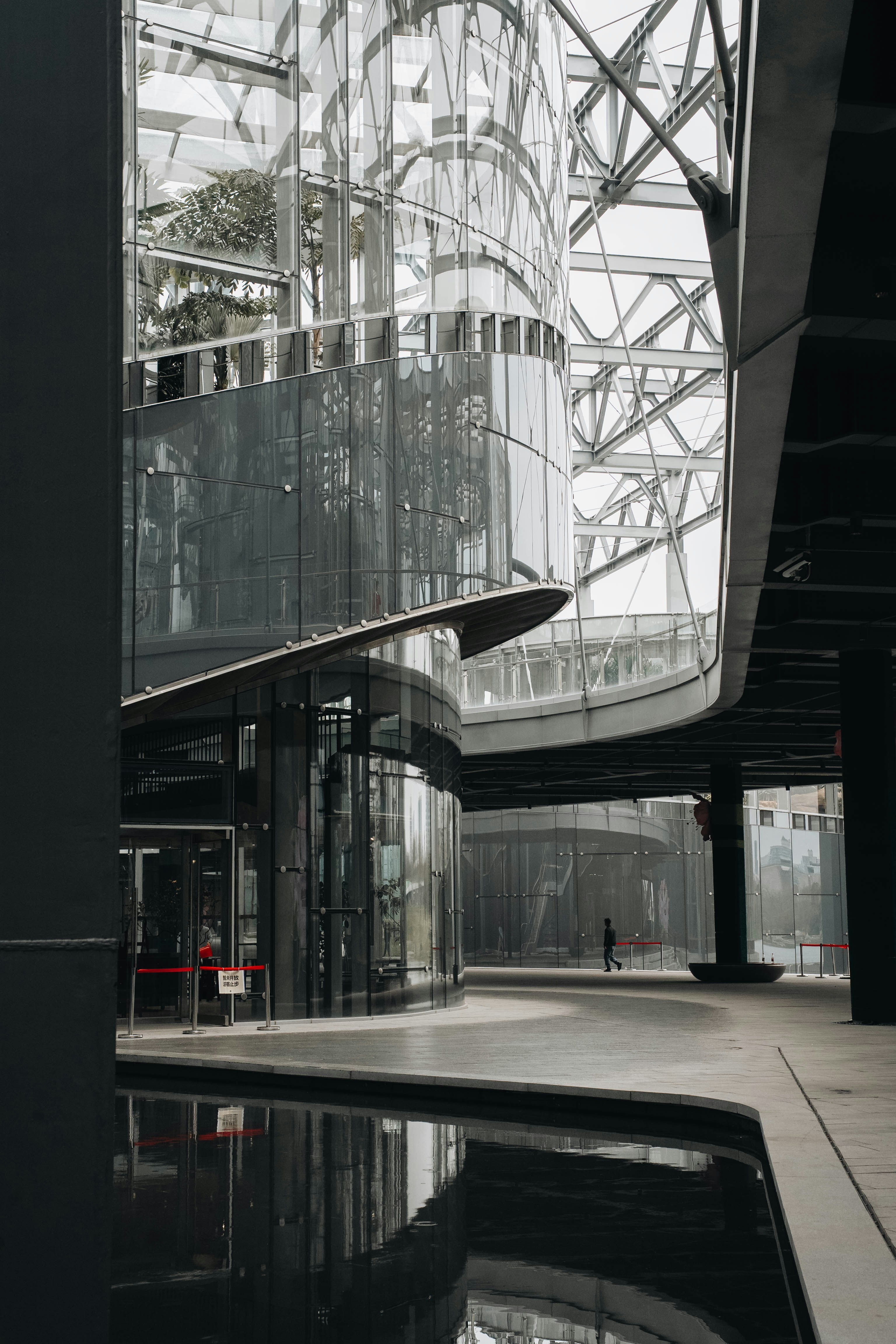 Curved Glass Facade and Shadowed Atrium of a Modern Transitique